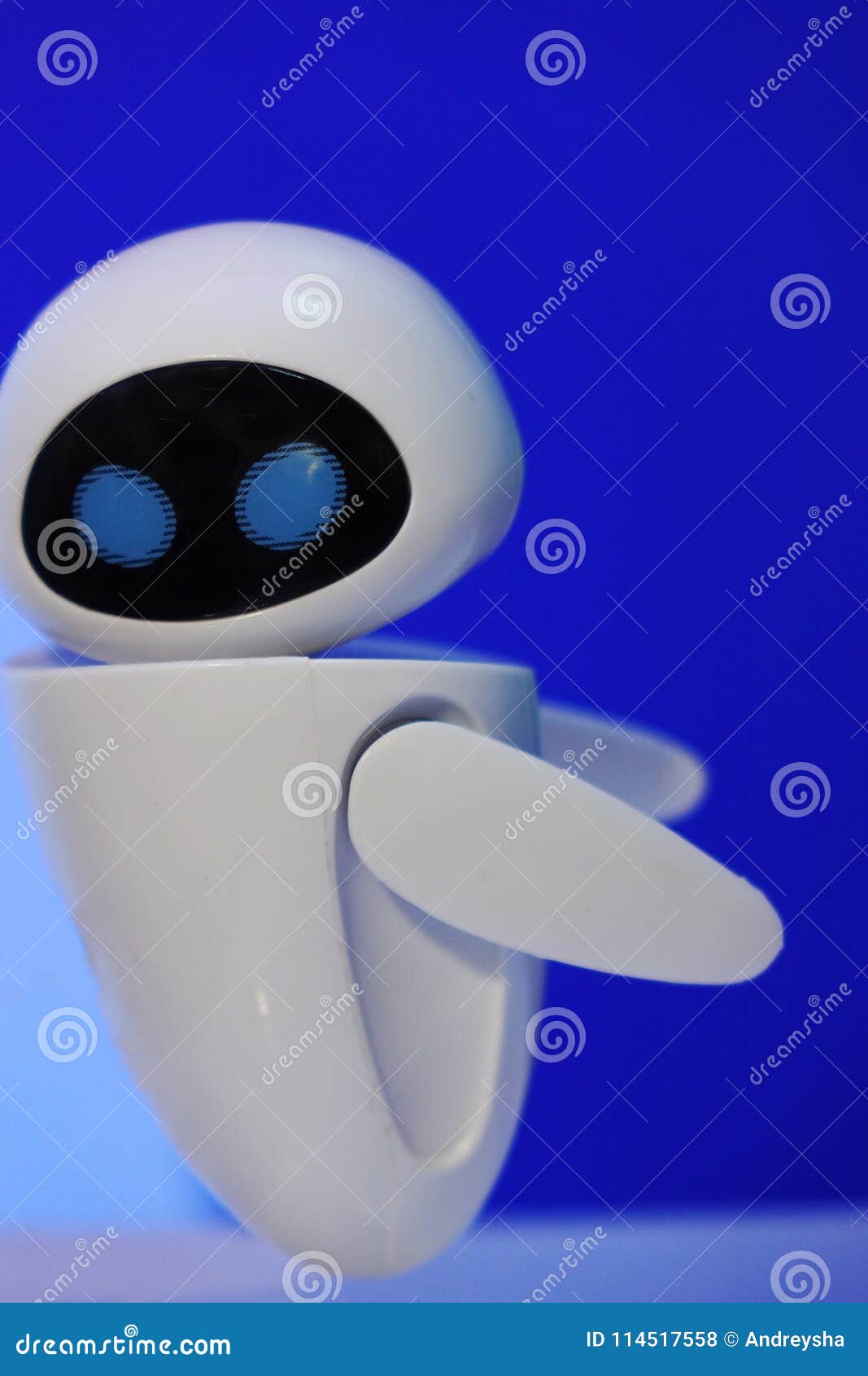 A Small Robot with a Humanoid Body on a Blue Background . Artificial ...