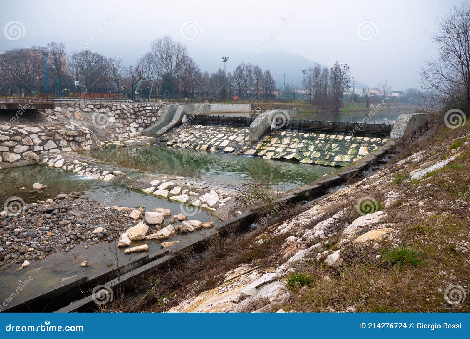 Small Rock Dam of a River in a Built-up Area Stock Photo - Image of ...