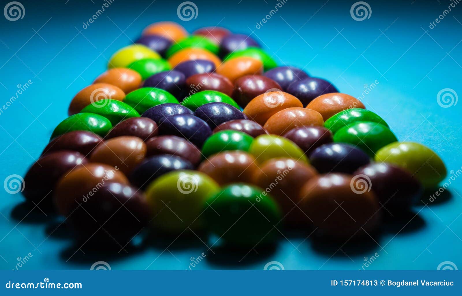 Small, Round Candies of Different Colors, on a Blue Background Stock ...