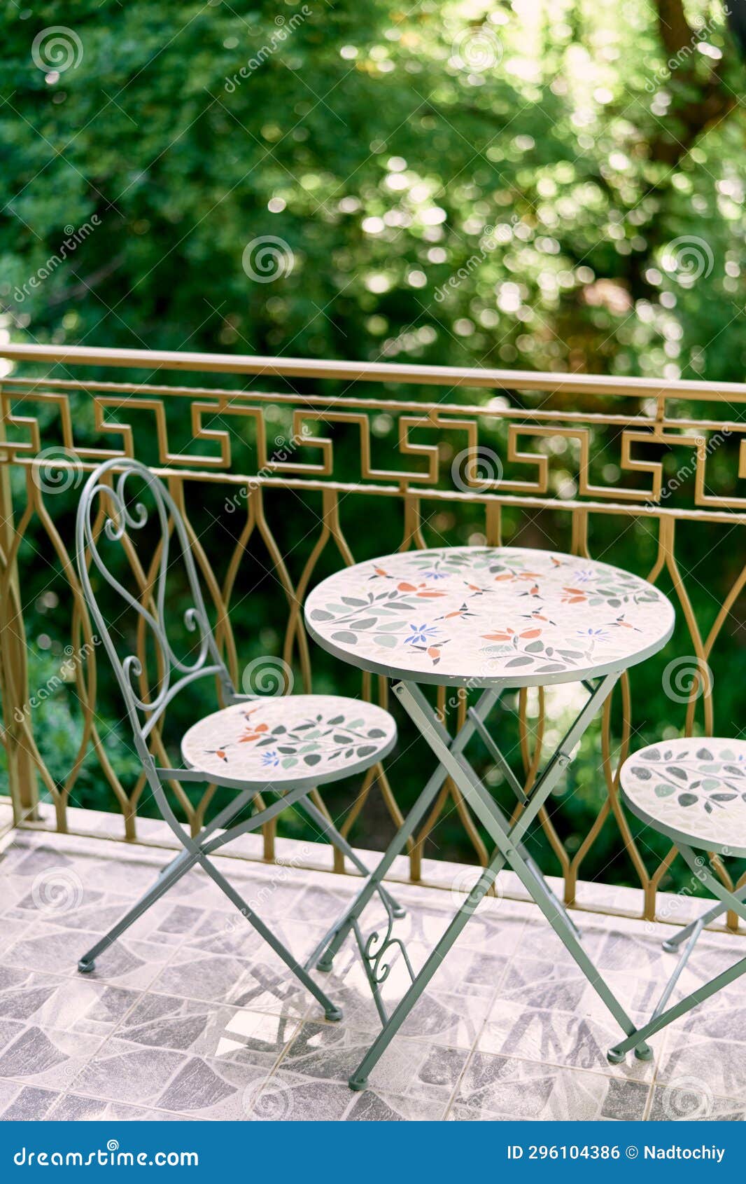 Small Round Table with Chairs with Backs Stands on the Balcony of the ...