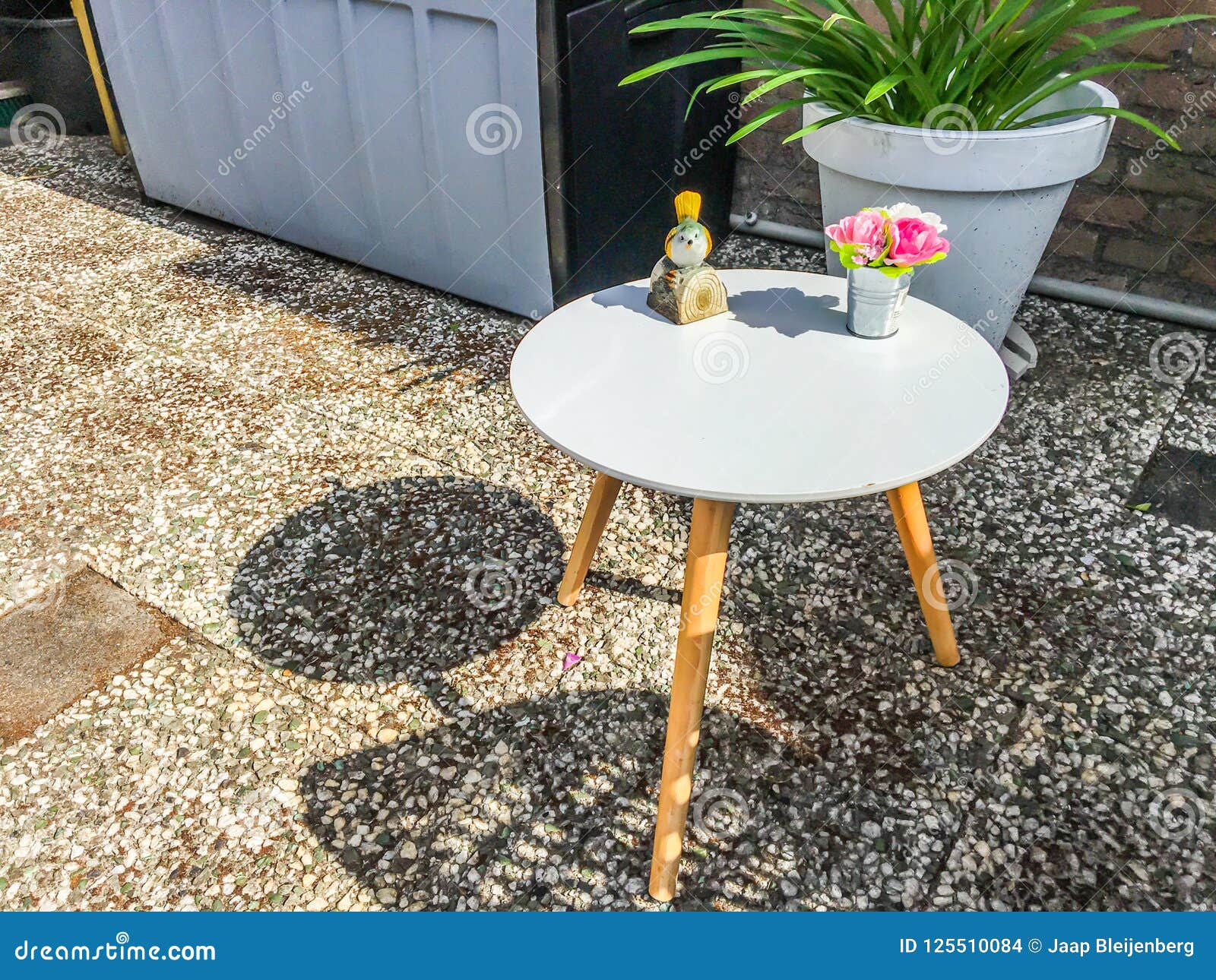 Small Round White Legged Table with Decorations on it in the Backyard ...
