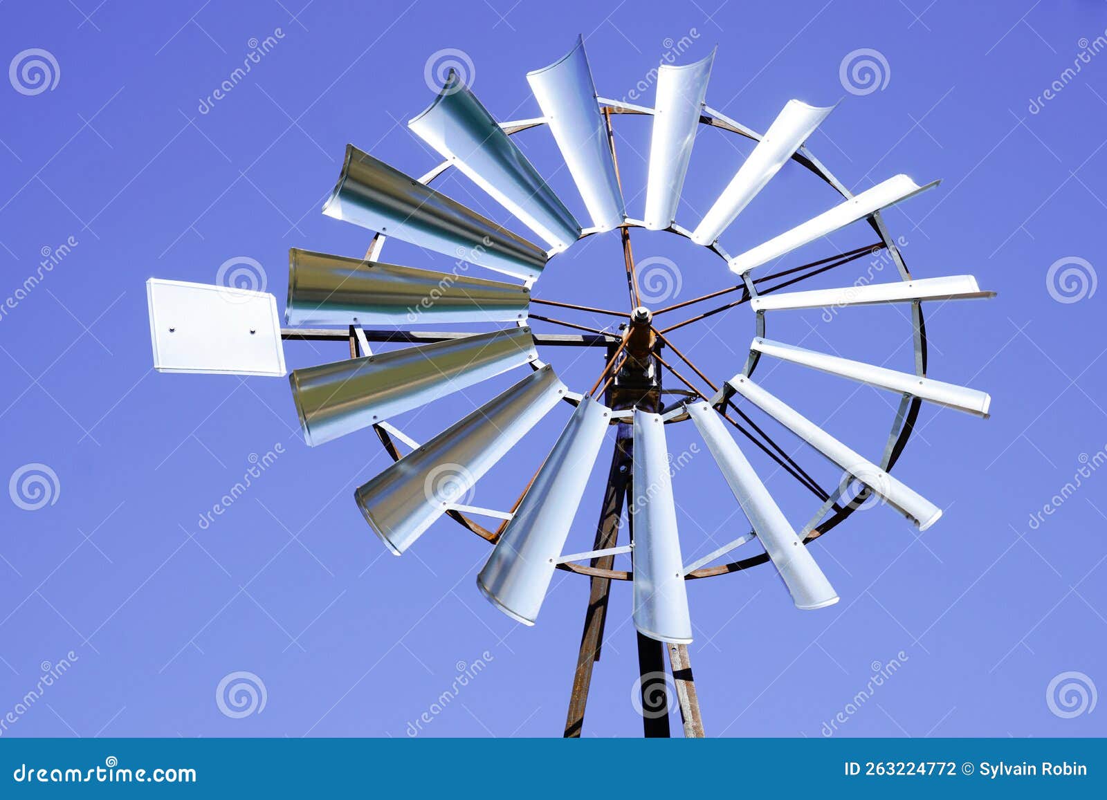 Small Rustic Windmill Vintage Wind Turbine in Blue Sky Stock Photo ...