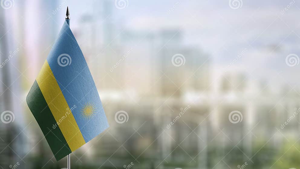 A Small Rwanda Flag on an Abstract Blurry Background Stock Image ...