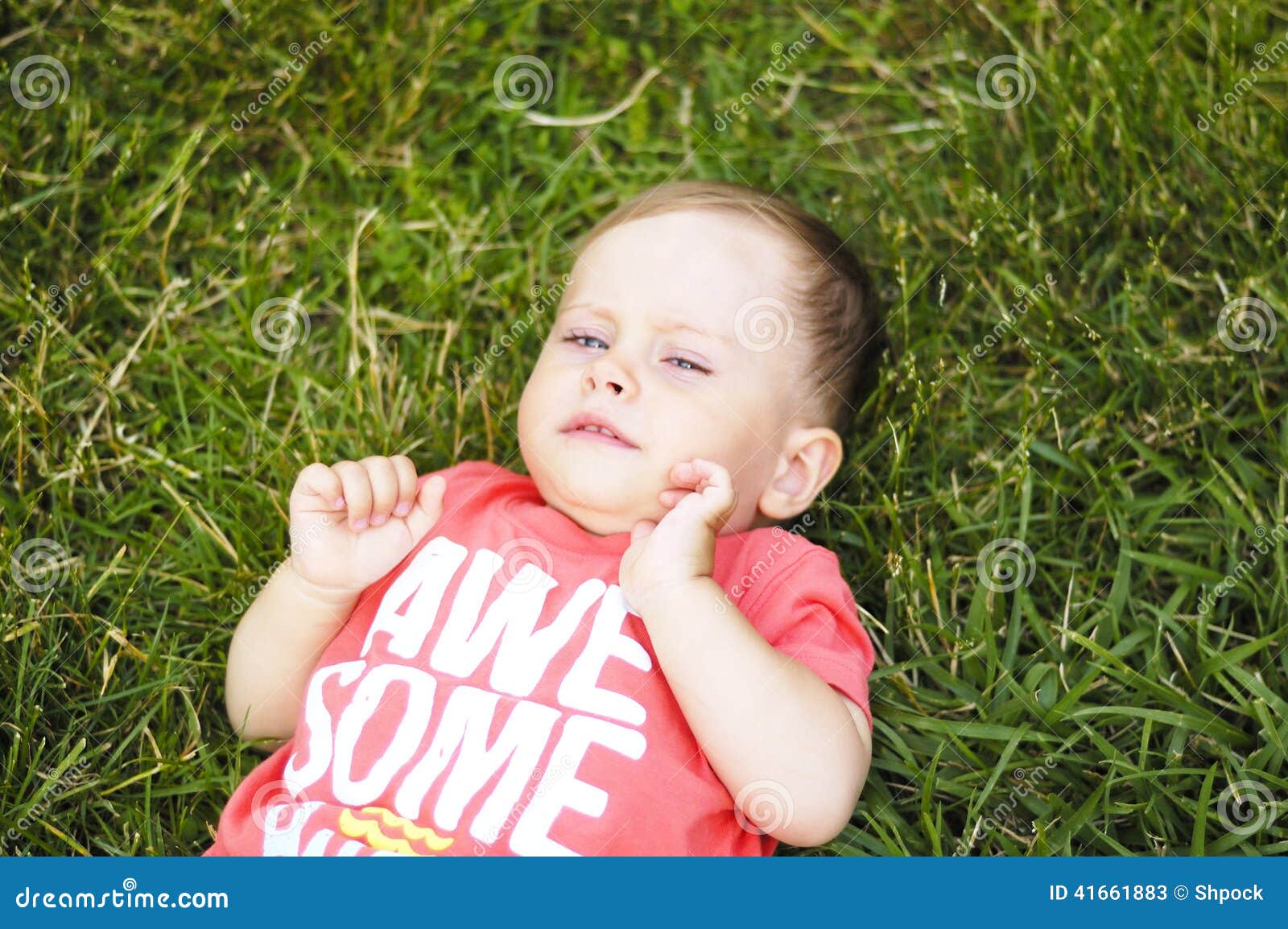 Small sad boy on grass stock image. Image of small, emotion - 41661883