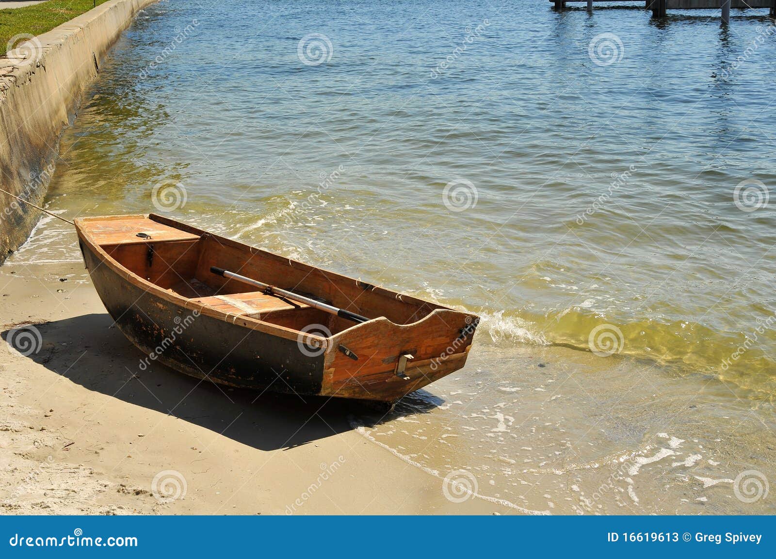 Small Sailboat Tied Off Againt a Seawall Stock Image - Image of pram ...