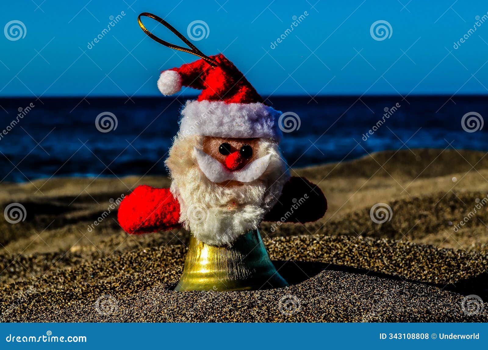 A Small Santa Claus Figurine is Sitting on a Beach Stock Photo - Image ...