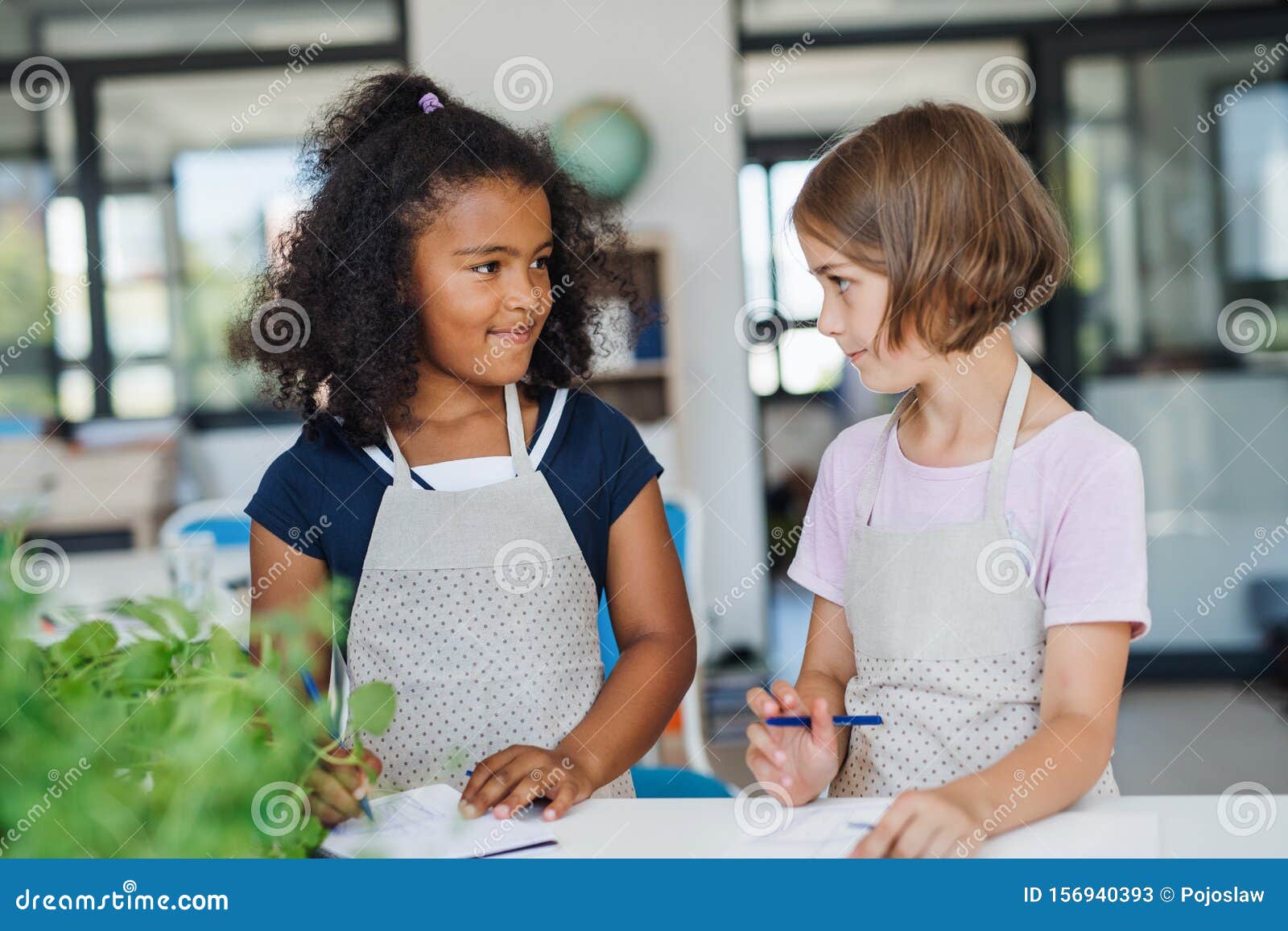 Small School Kids with Aprons Standing at the Desk in Class, Talking ...