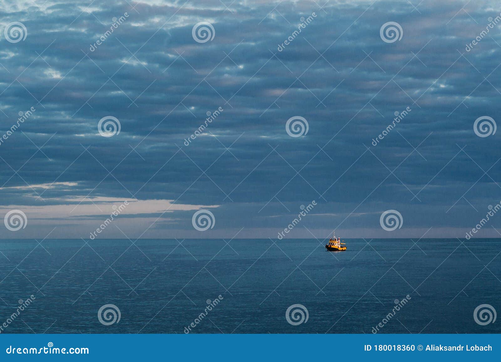 A Small Ship at Sea Against the Sunset Sky Stock Photo - Image of ...