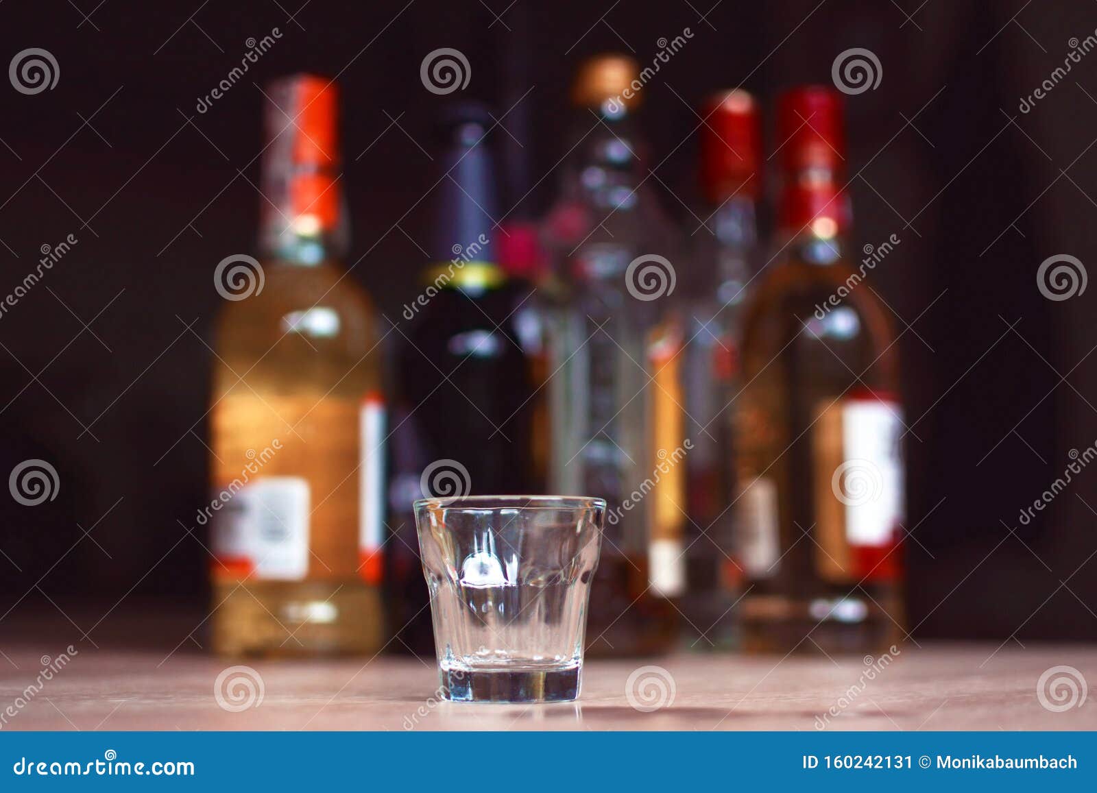 Small Shots Glass in Front of Multiple Blurry Different Strong Spirits ...