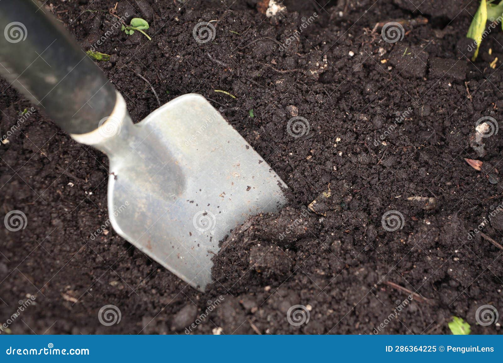 Small Silver and Black Gardening Shovel Mixing Dirt Soil in Various ...