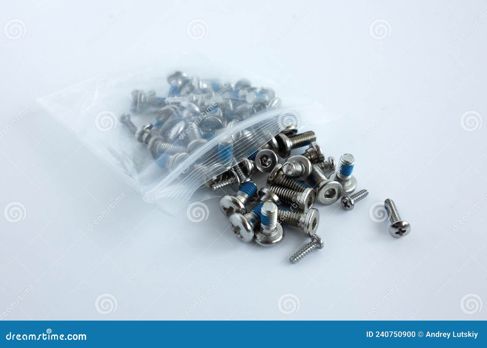 Small Silver Cogs on a White Isolate. a Plastic Bag with Screws for ...