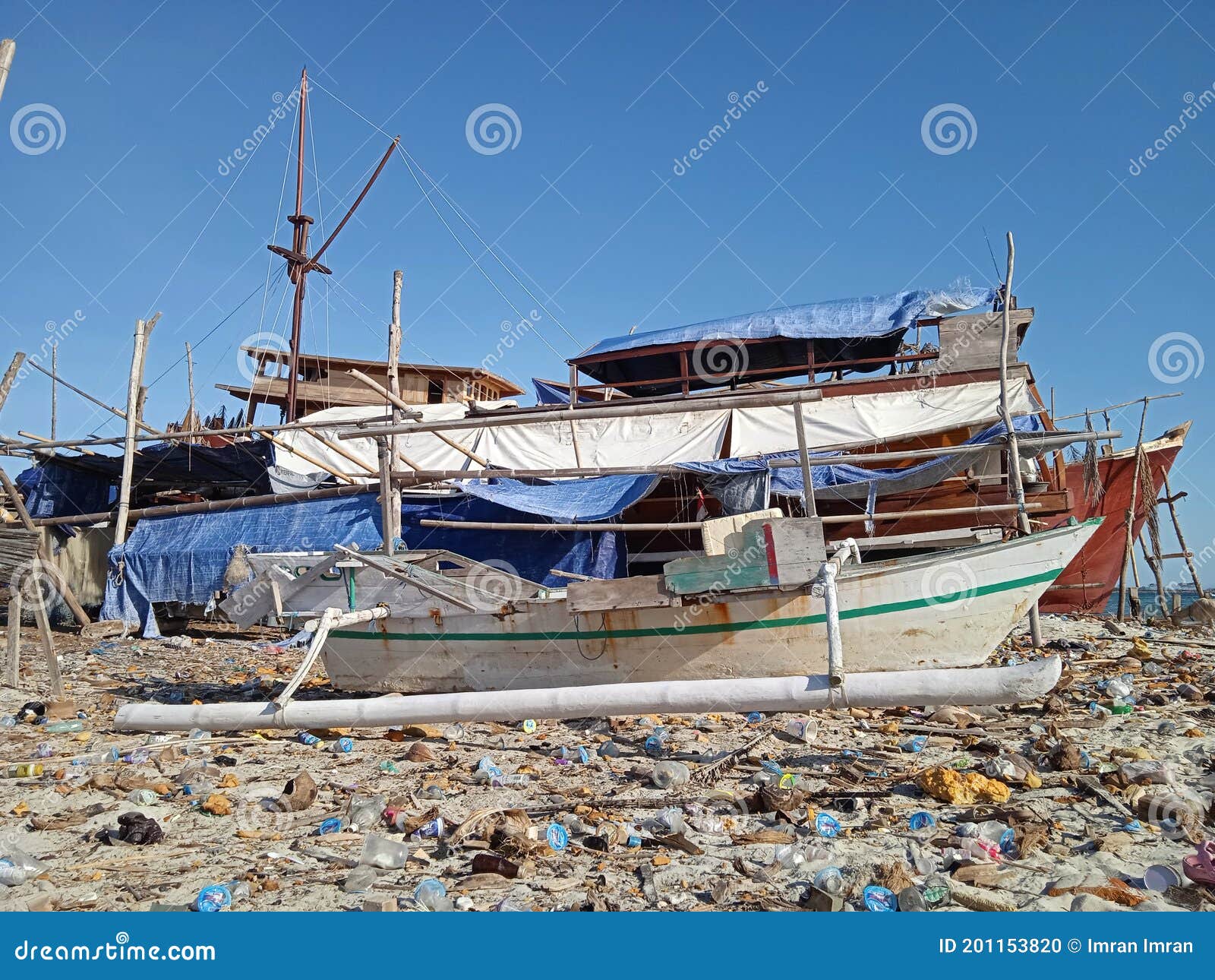 A Small and Simple White Boat on the Edge of the Sea and Several ...
