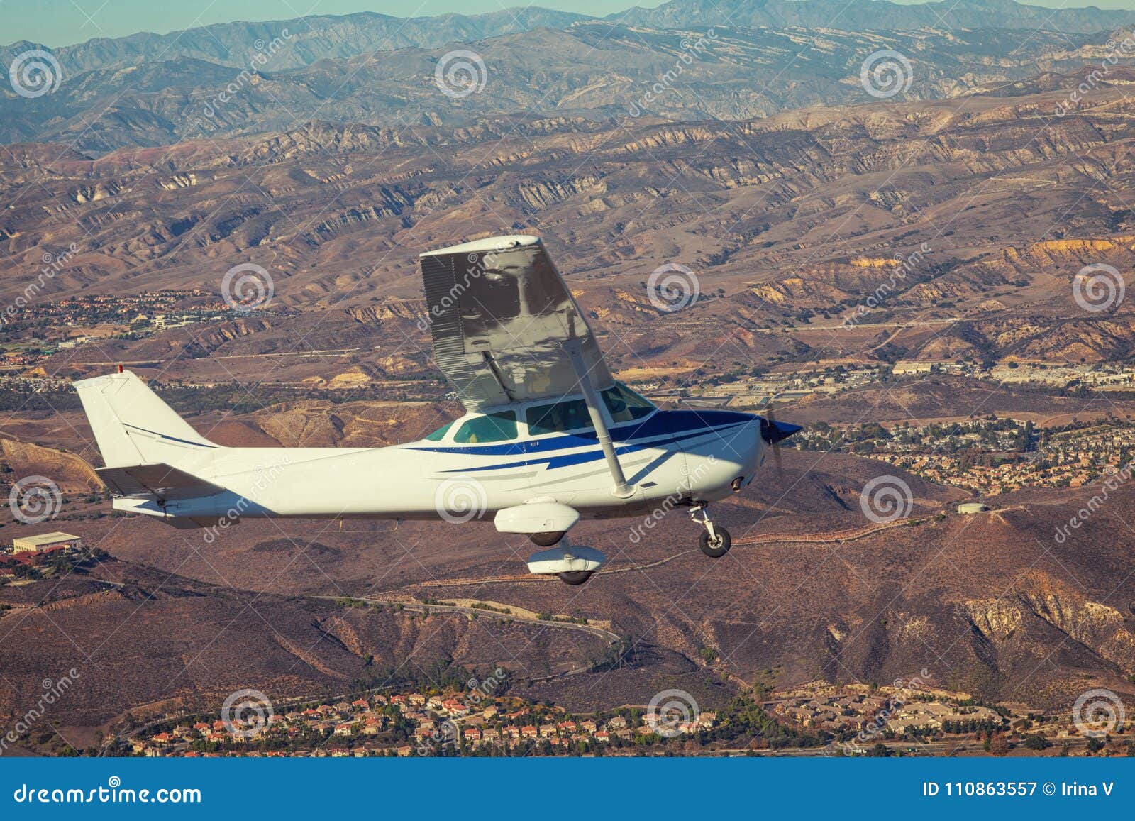 Small Airplane Flying in the Sky Over the Mountains Stock Image - Image ...