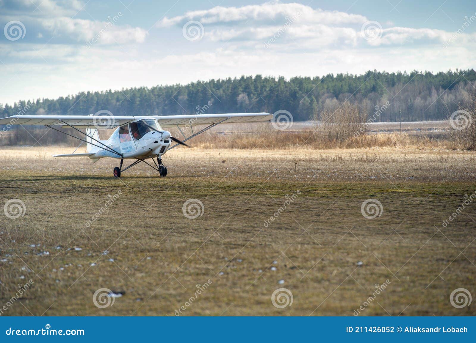 A Small Single-engine Plane Makes a Landing on the Ground Stock Photo ...