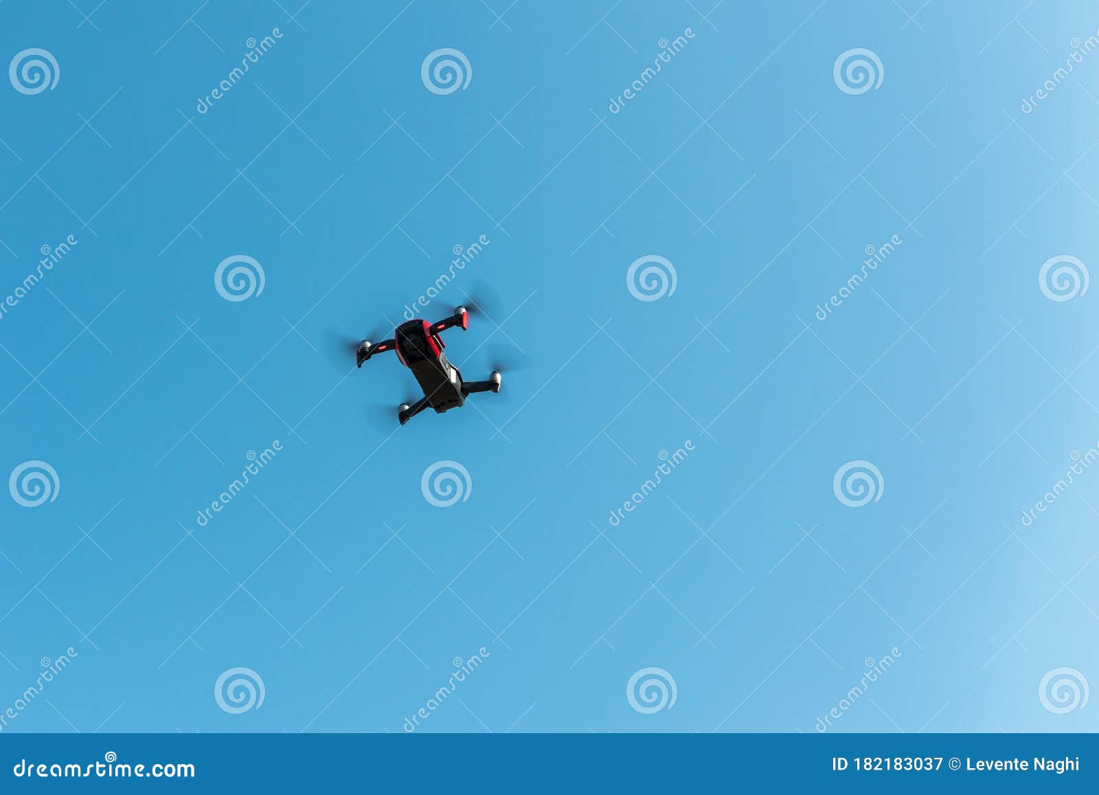 Small Sized Red Drone with High Resolution Camera Hovering in Air for ...