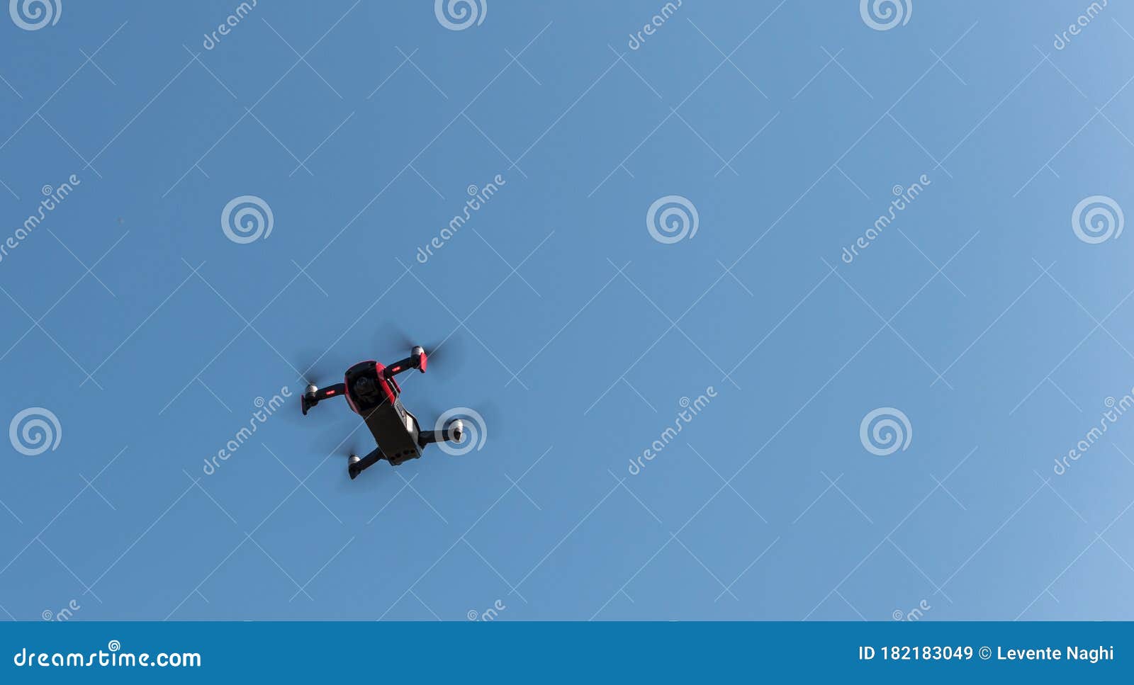 Small Sized Red Drone with High Resolution Camera Hovering in Air for ...