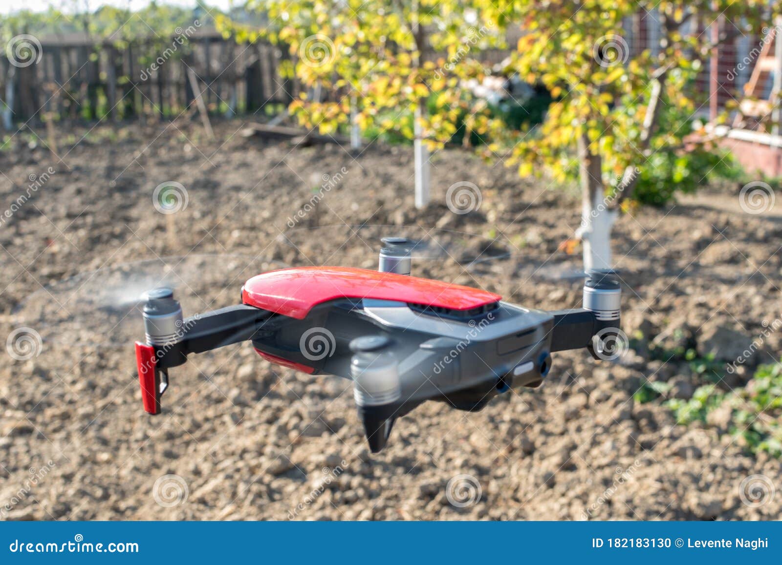 Small Sized Red Drone with High Resolution Camera Hovering in Air for ...