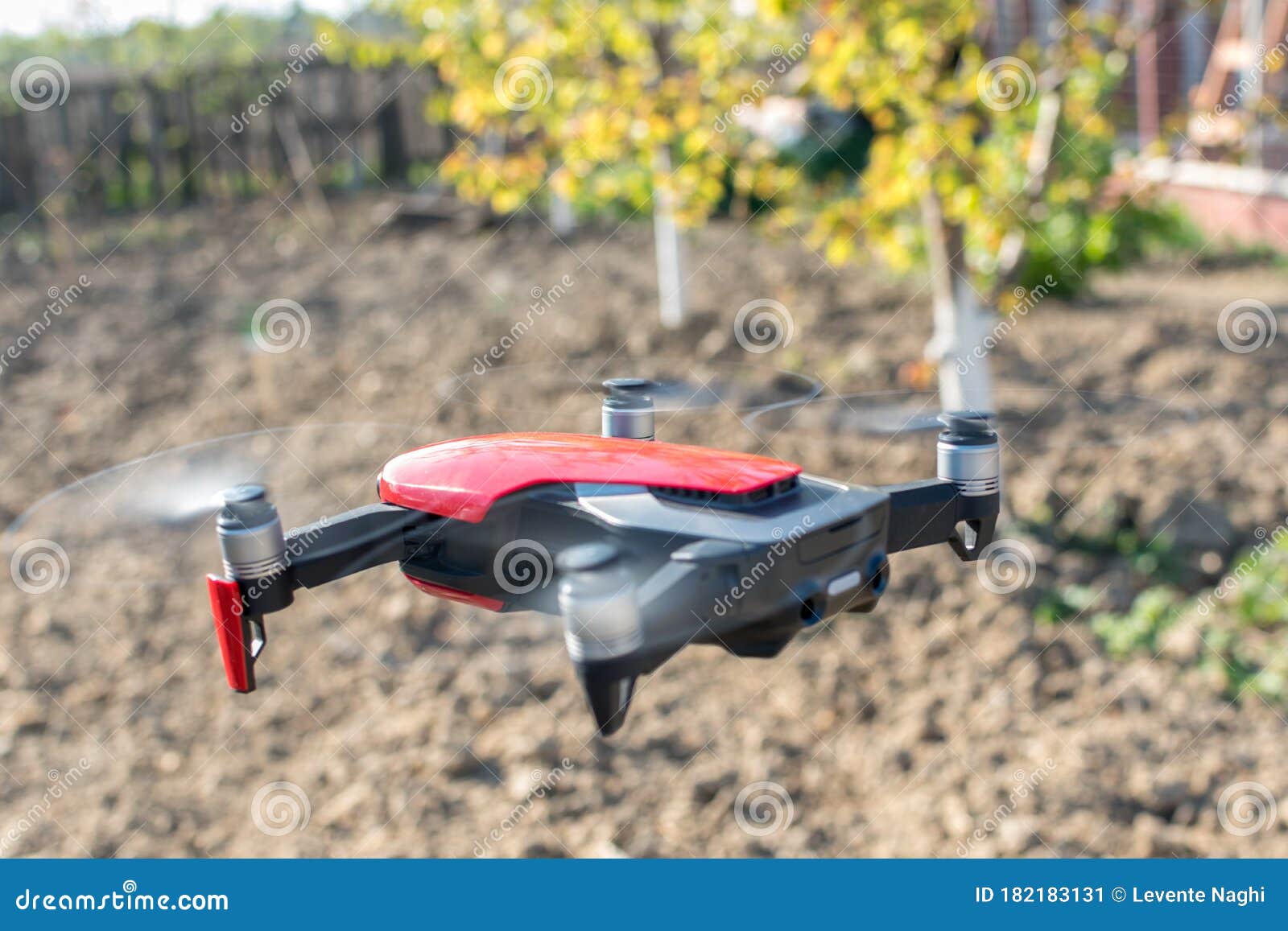 Small Sized Red Drone with High Resolution Camera Hovering in Air for ...