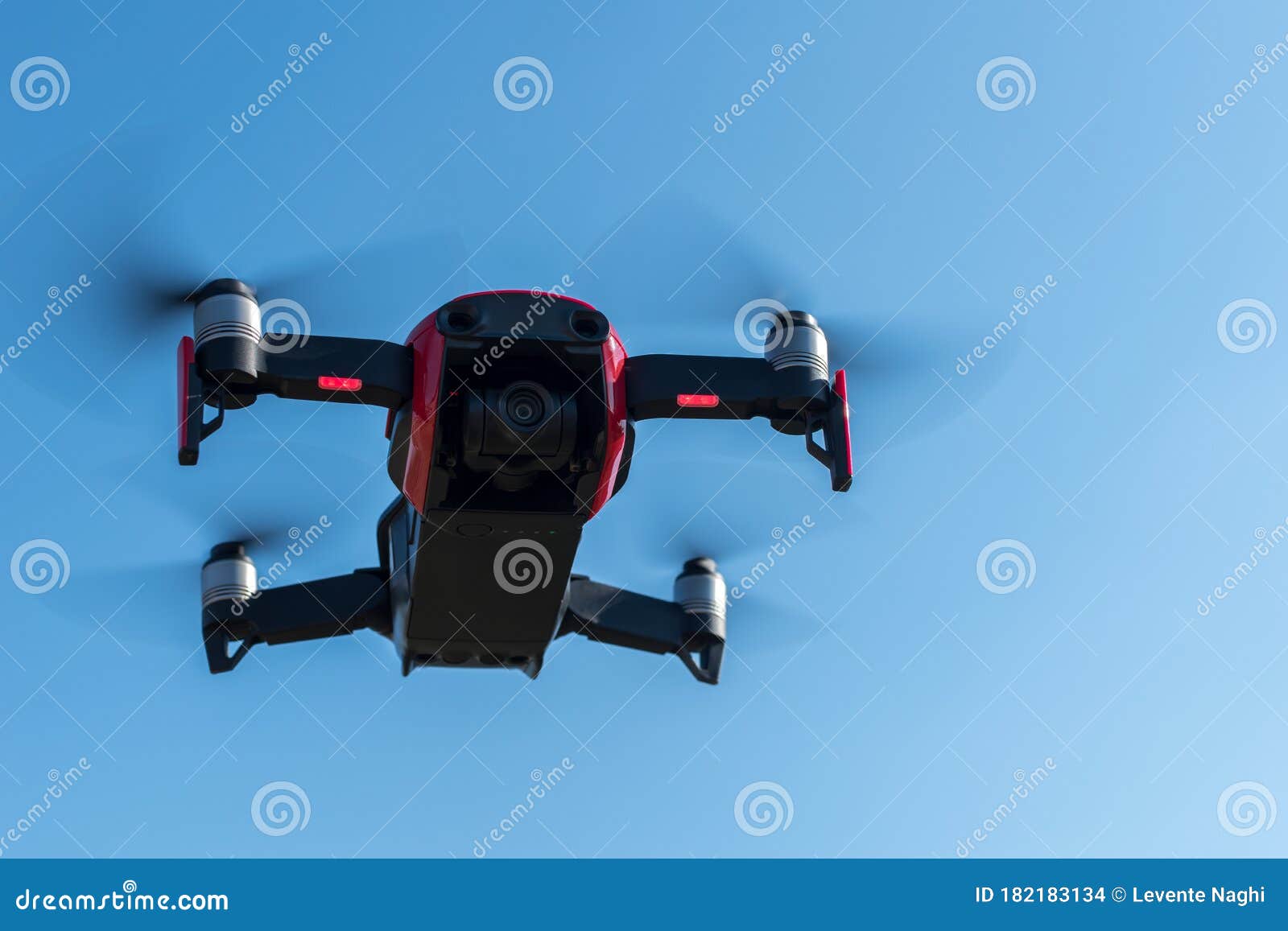 Small Sized Red Drone with High Resolution Camera Hovering in Air for ...