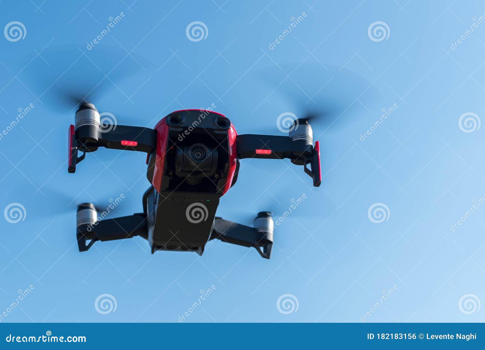 Small Sized Red Drone with High Resolution Camera Hovering in Air for ...