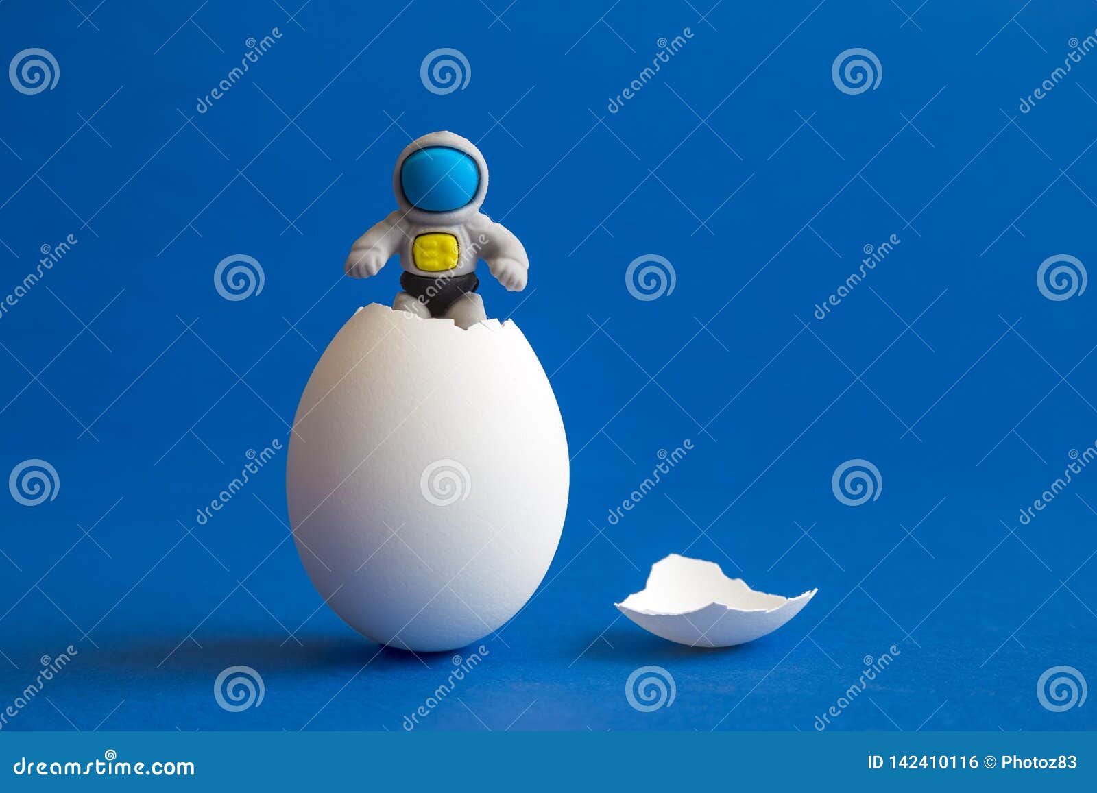 Small Spaceman on the Top of Broken Egg Abstract on Dark Blue Space ...