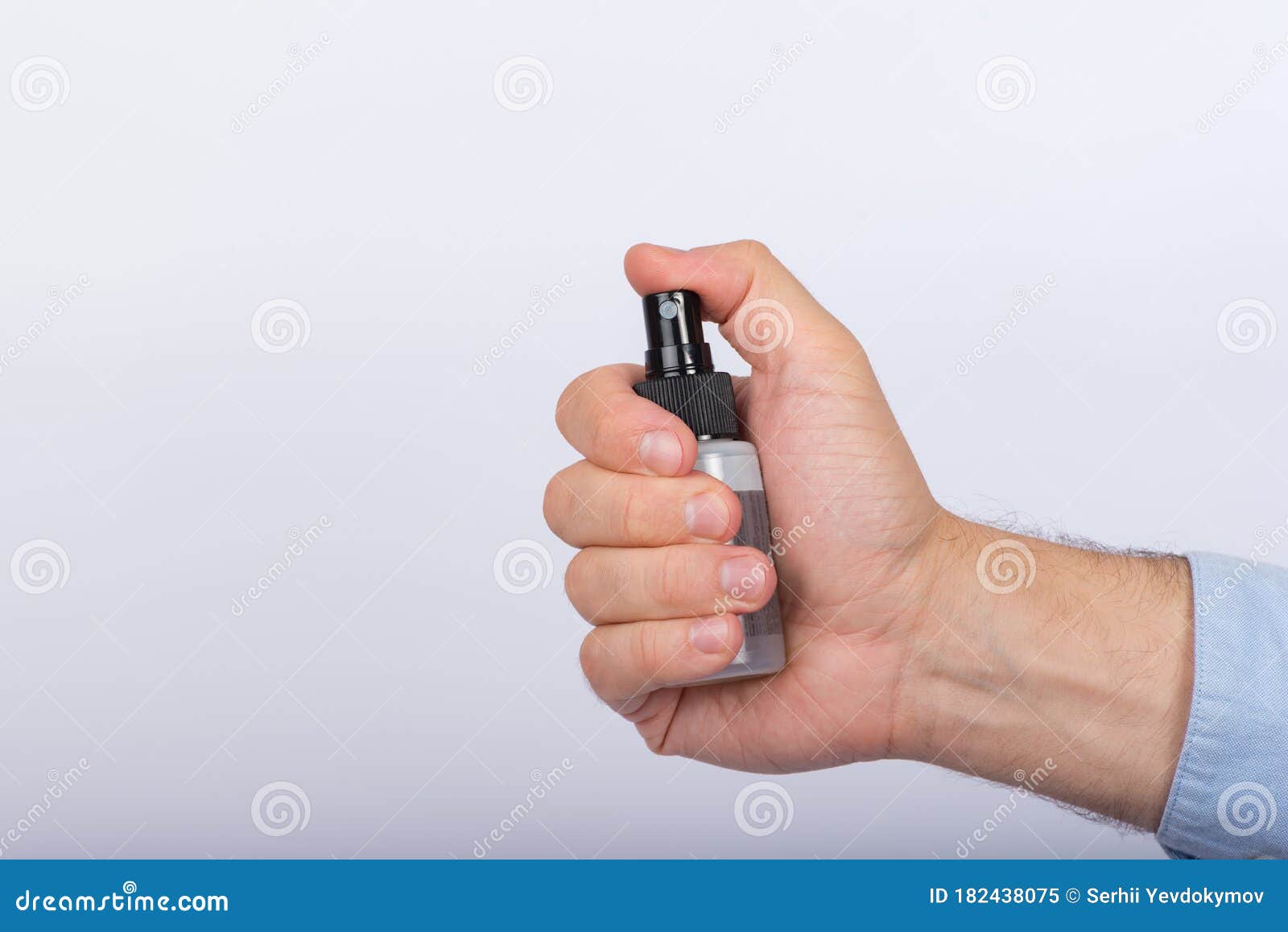 Small Spray Bottle in Male Hand. White Background Stock Image - Image ...
