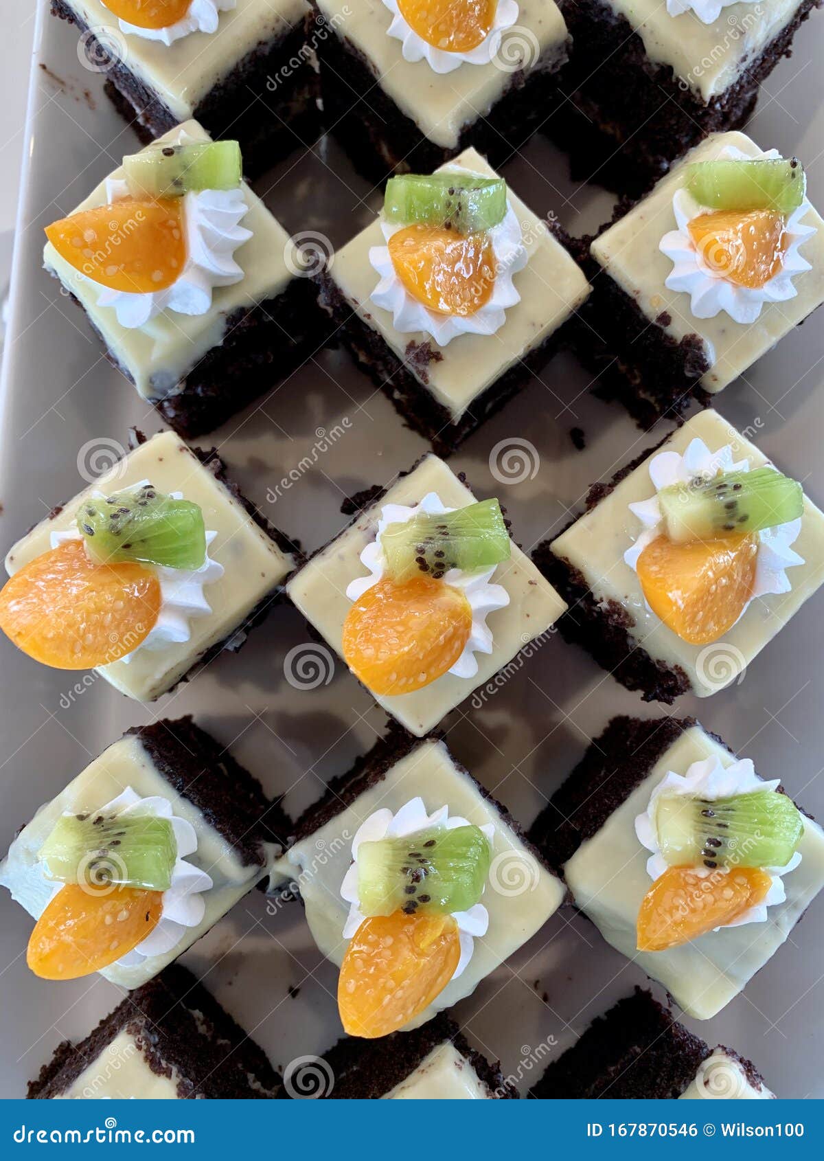 Small Desserts Cut into Squares with Fruit Stock Photo - Image of cream ...