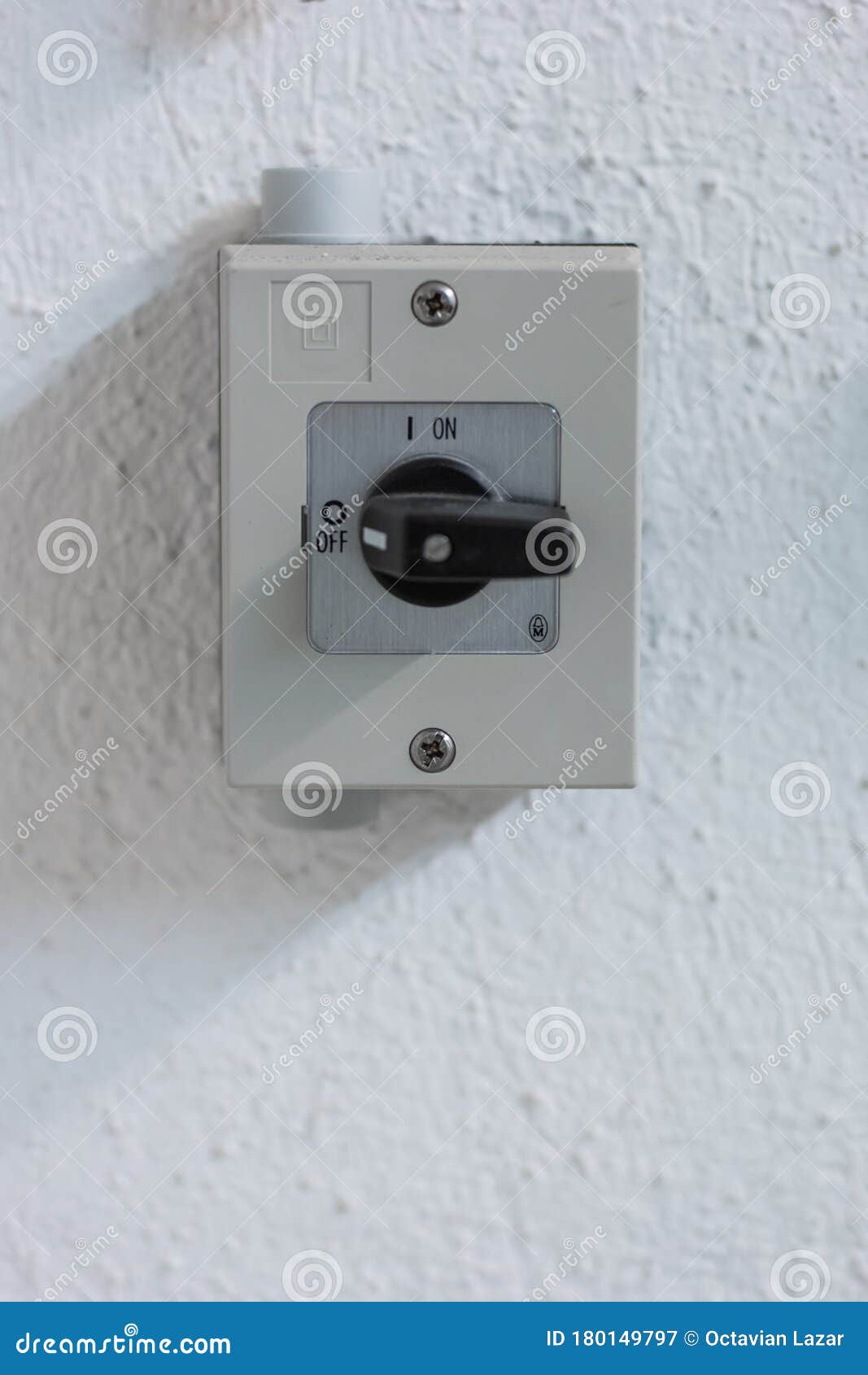 Small Square Electric Switch Box with on Off Markings Set on a Wall ...