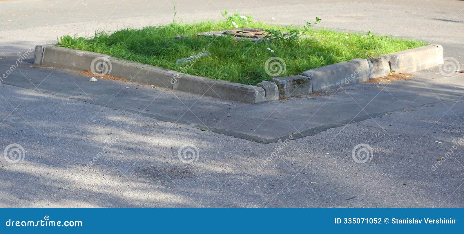 Small Square Lawn with a Sewer Manhole Surrounded by a Concrete Curb ...
