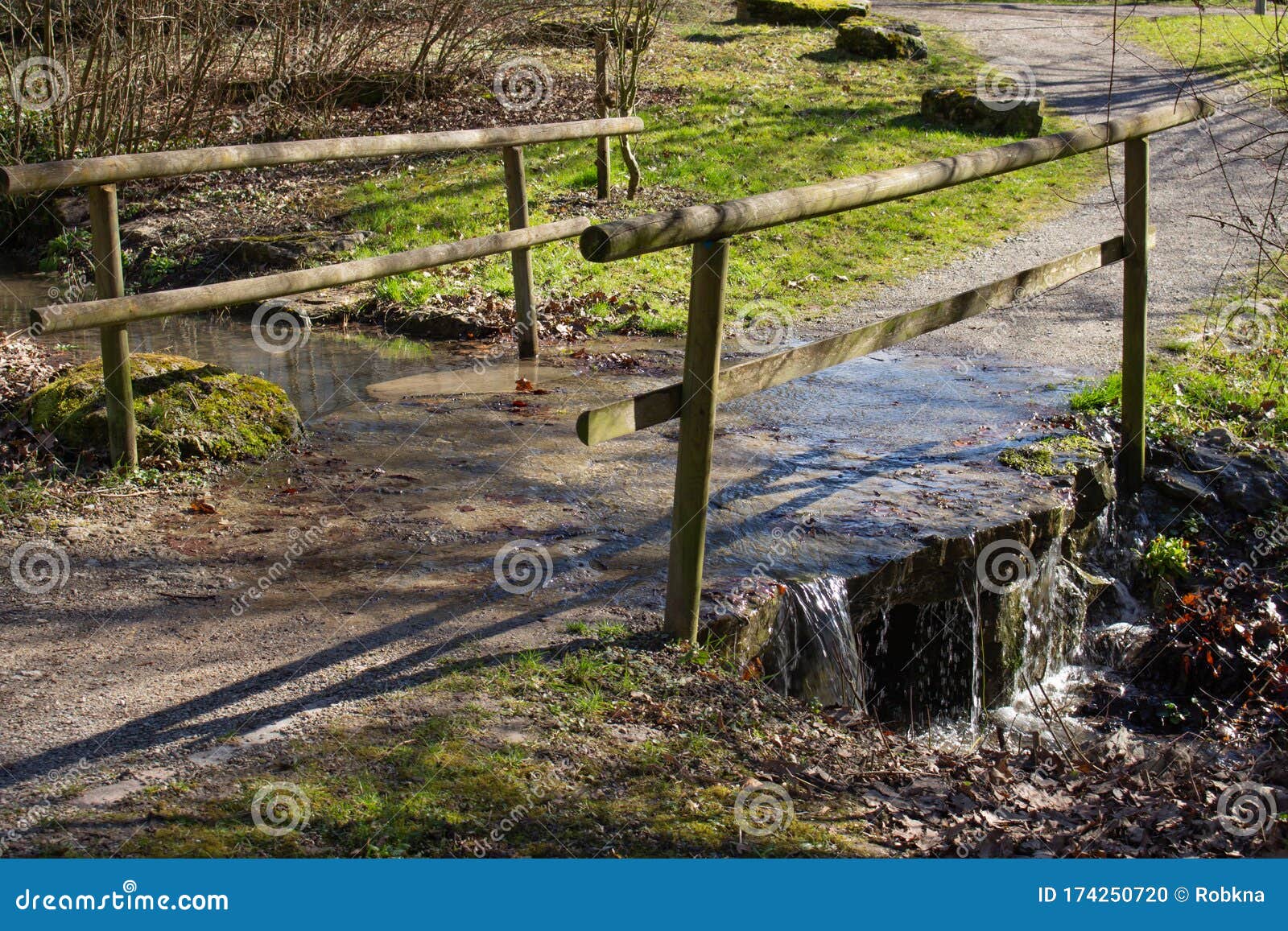 Small Stone Bridge for a Footpath Over a Small Creek Flooded with Water ...