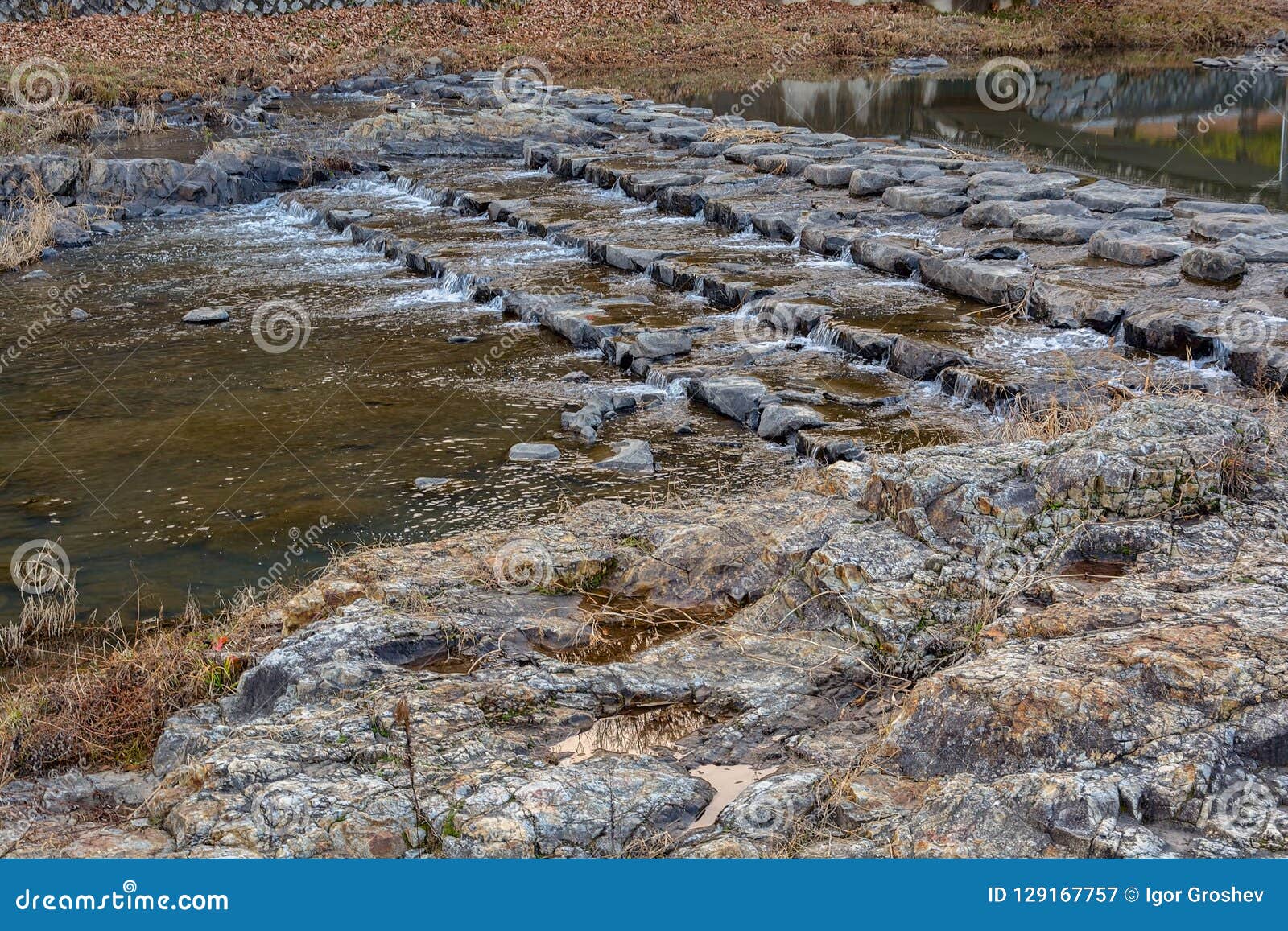Small stone dam on stream. stock image. Image of nature - 129167757