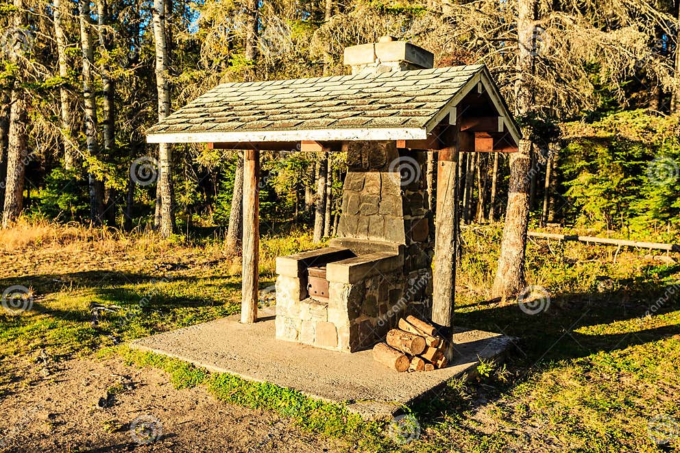 A Small Stone Structure with a Chimney and a Fire Pit Stock Photo ...