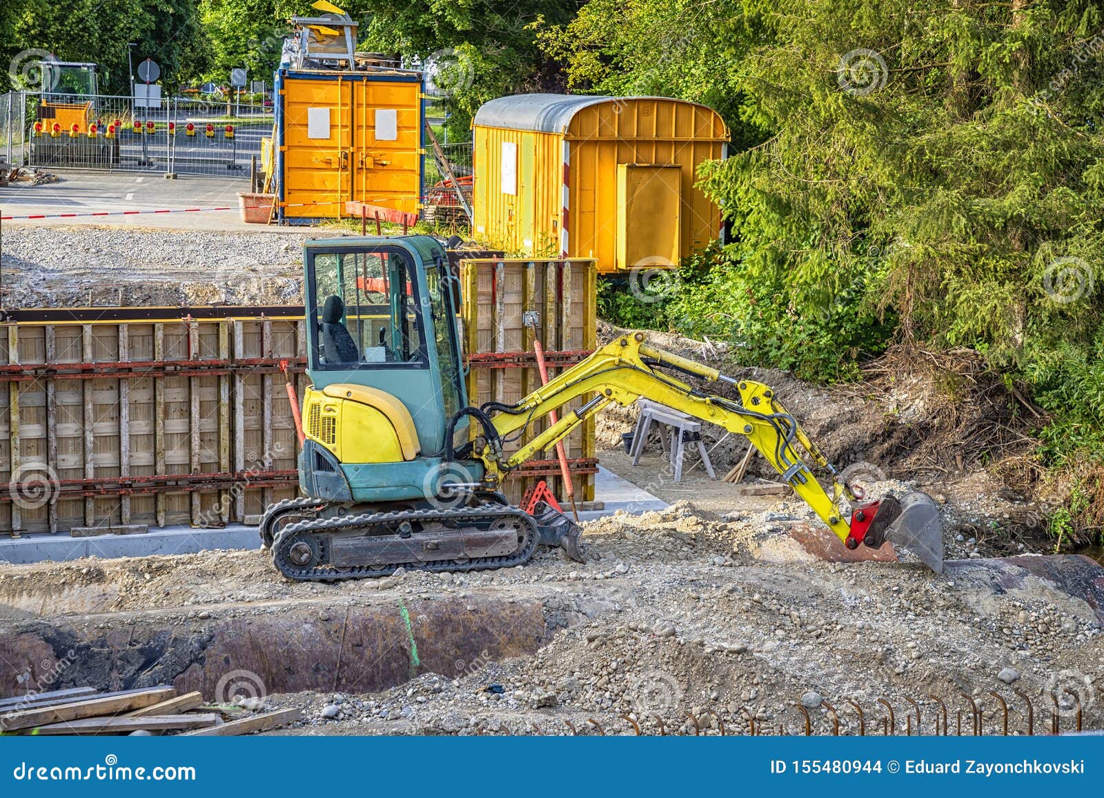 Small Stopped Excavator with a Shovel and Building Site Containers ...