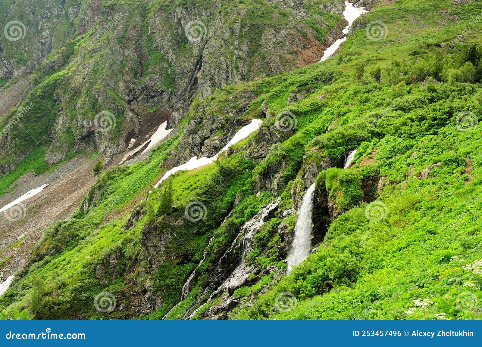 A Small Stormy Waterfall Flows Down a Steep Cliff in a Swift Stream ...
