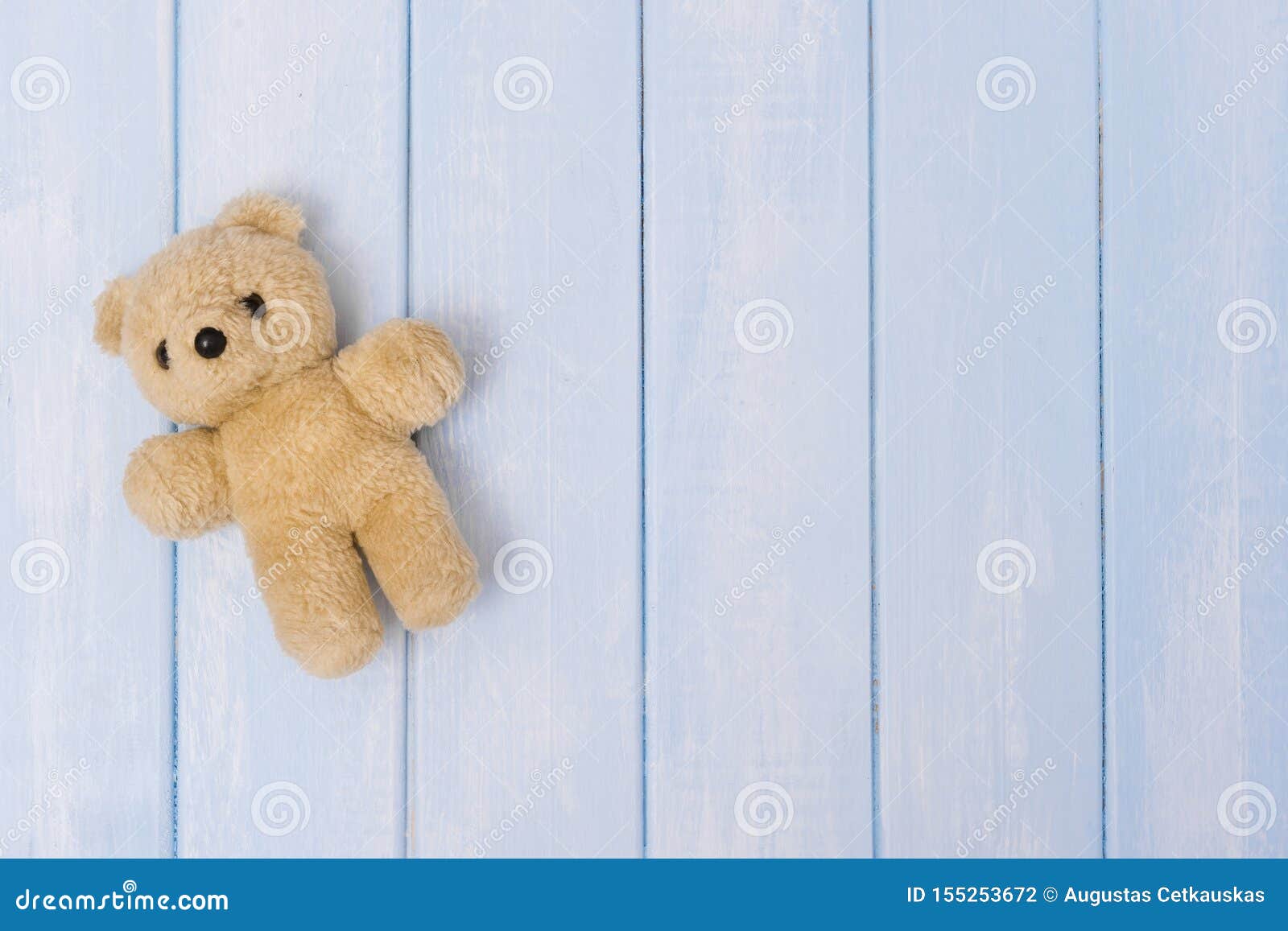 Small Teddy Bear on Blue Pastel Wooden Background, Top View Stock Photo ...