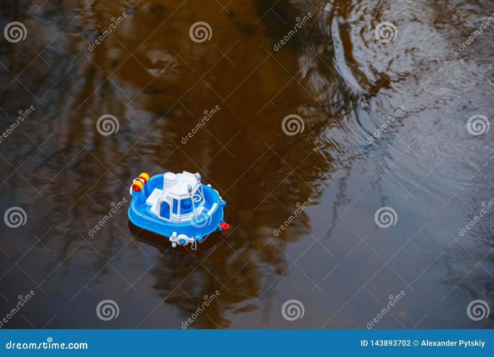 A Small Toy Boat Sails Along a Forest River at Sunset Stock Photo ...