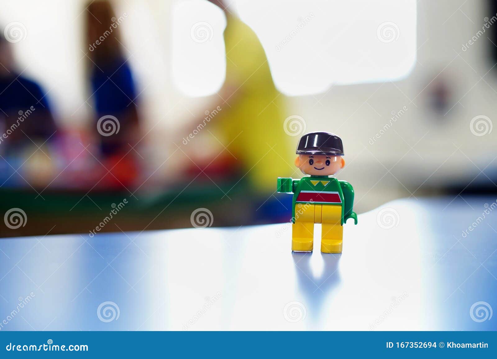 A Small Toy Human Figure Standing Alone on the Table with Open Space ...
