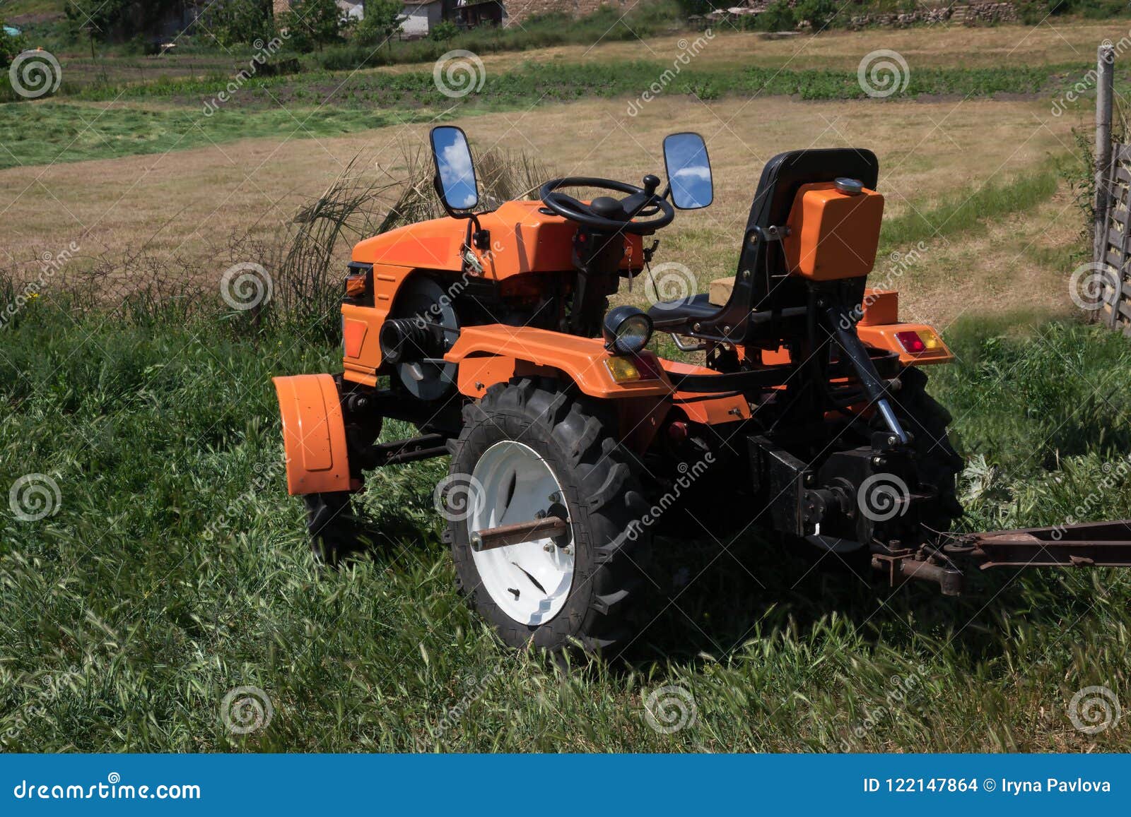 A Small Tractor is Working on the Field Stock Photo - Image of green ...