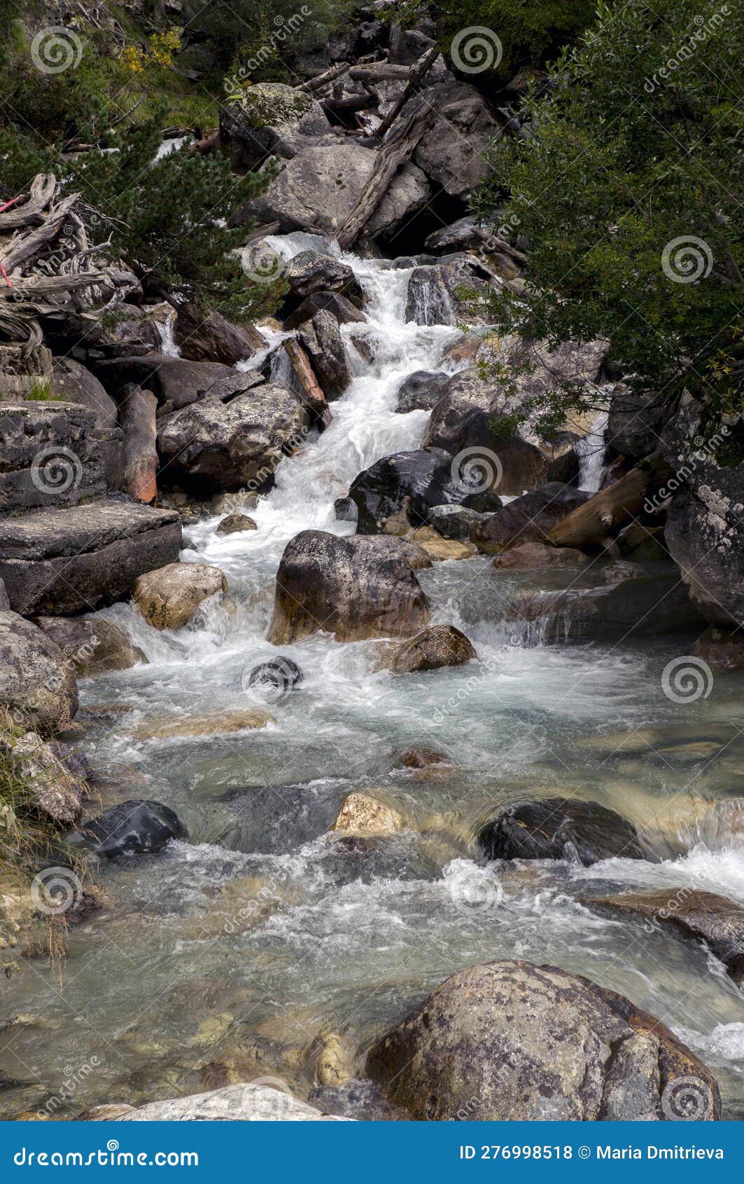A Small Waterfall. Water Stream Passing through Big Rocks. Mountain ... A Small Waterfall. Water Stream Passing through Big Rocks. Mountain ...
