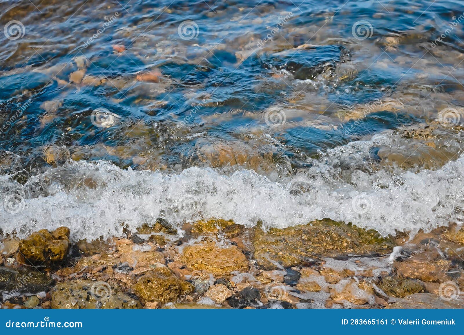 A Small Wave Rolls on the Seashore. Multi-colored Stones Underwater ...