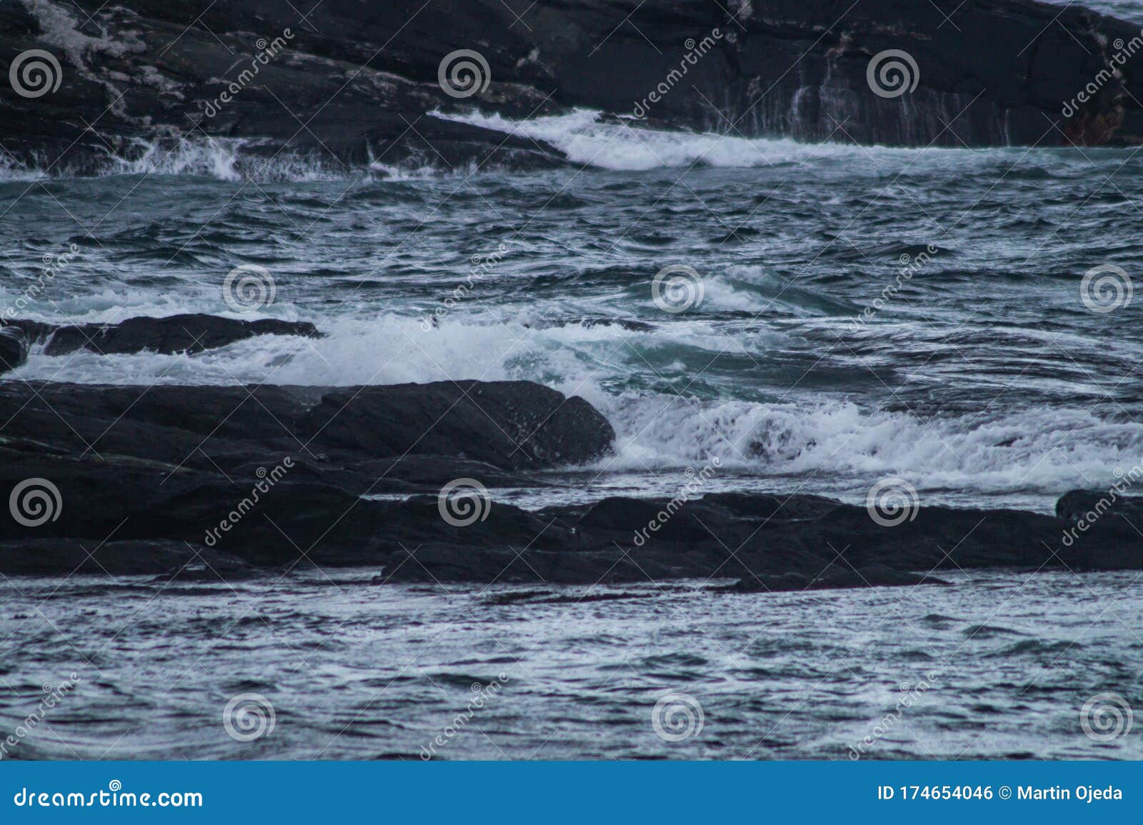 Small Waves Hitting Dark Rocks from the Ocean Stock Photo - Image of ...
