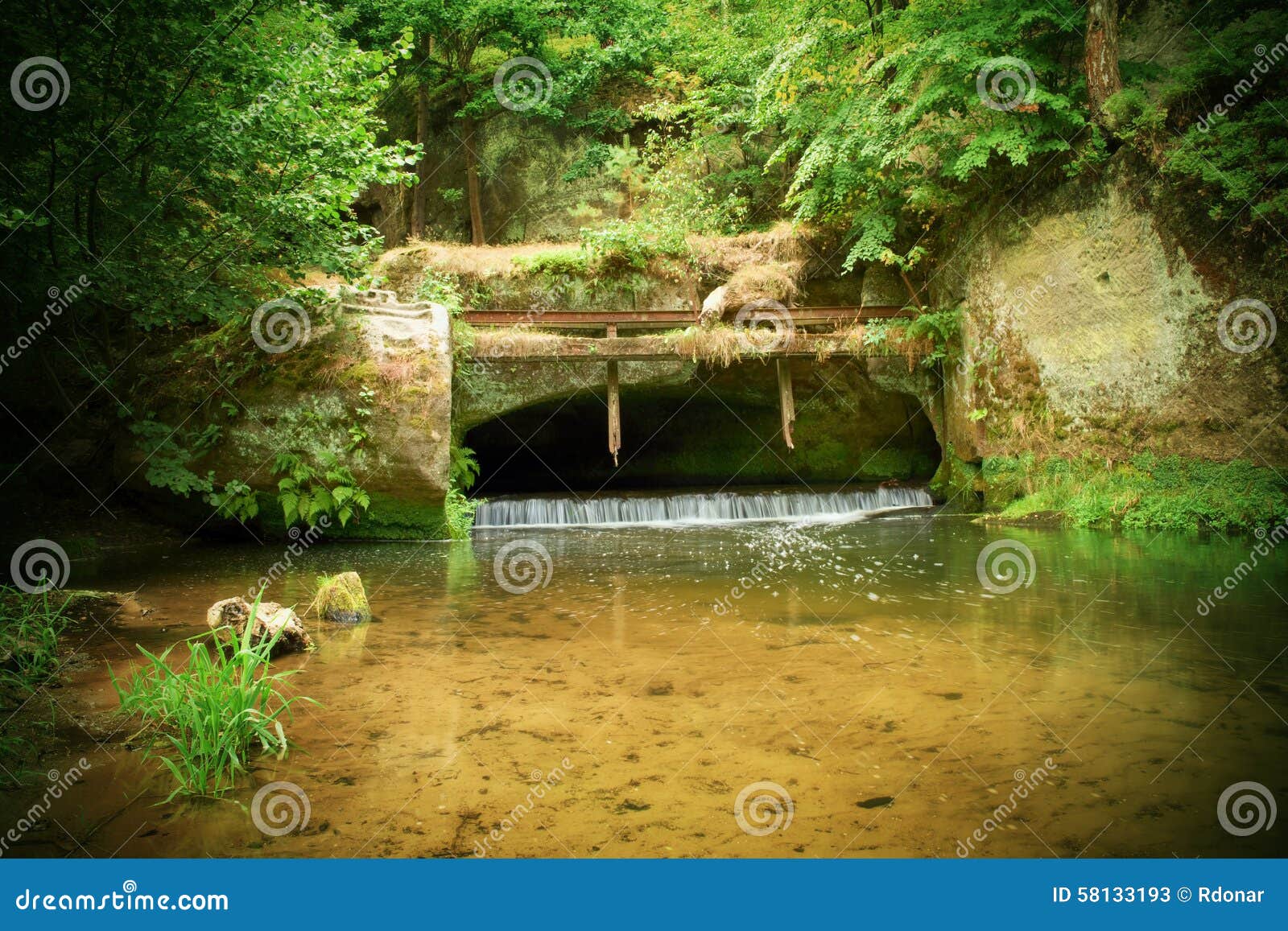 Small Weir on River Flows Out from Cave. Cold Water of Small River Flow ...