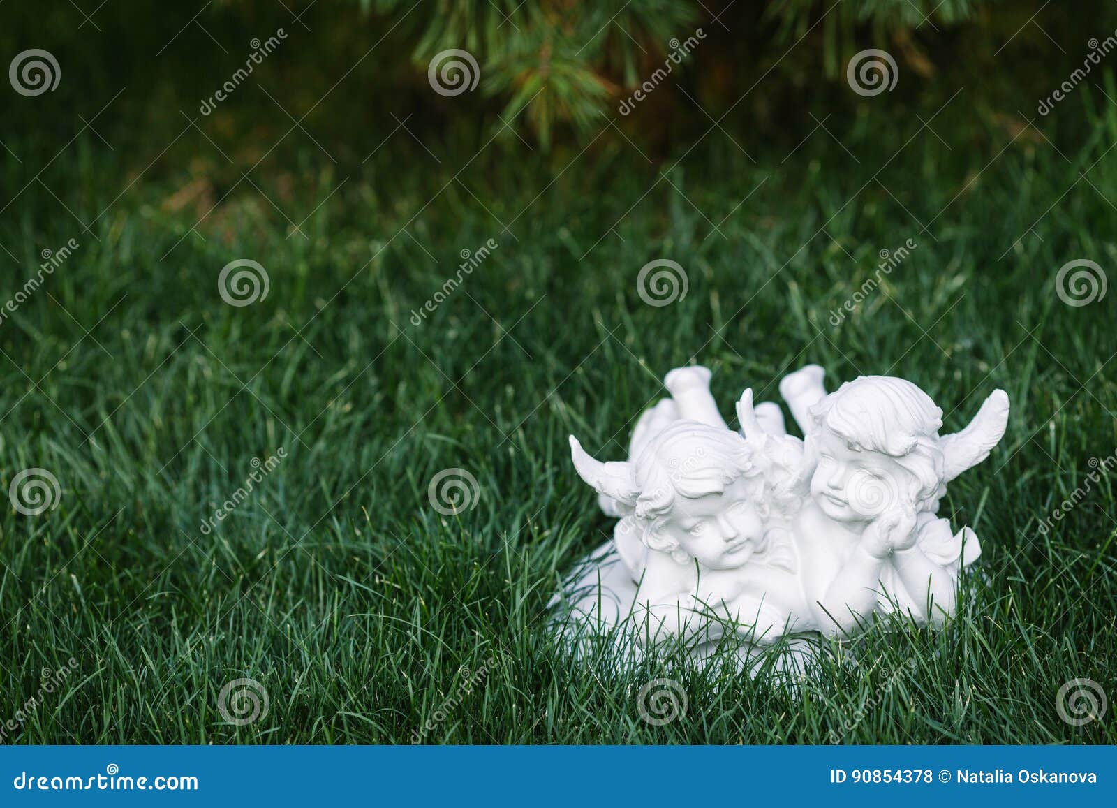 Small White Figurine of Two Angels in Grass Stock Photo - Image of ...