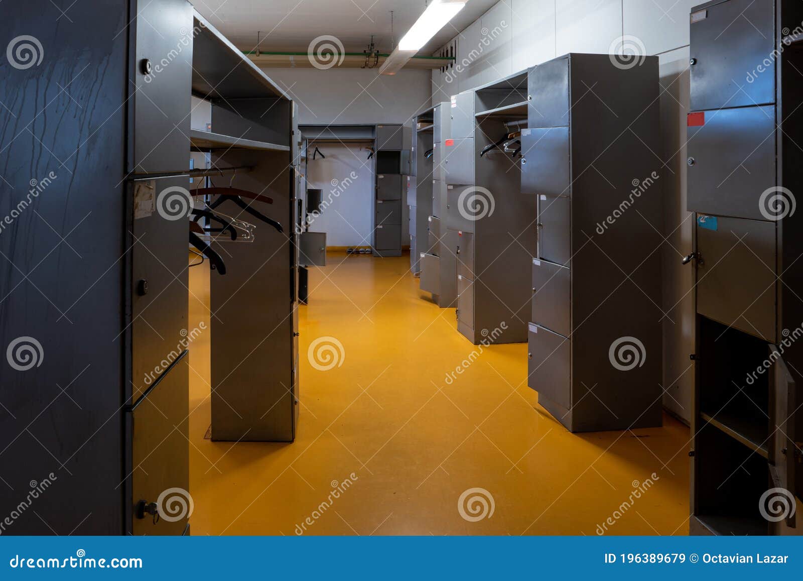 Small Work Place Locker Room for Workers with Opened Lockers and Yellow ...