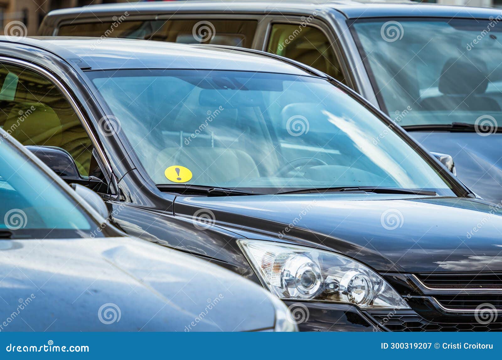 Small Yellow Beginner Driver Sign Sticker on the Windshield of a Parked ...