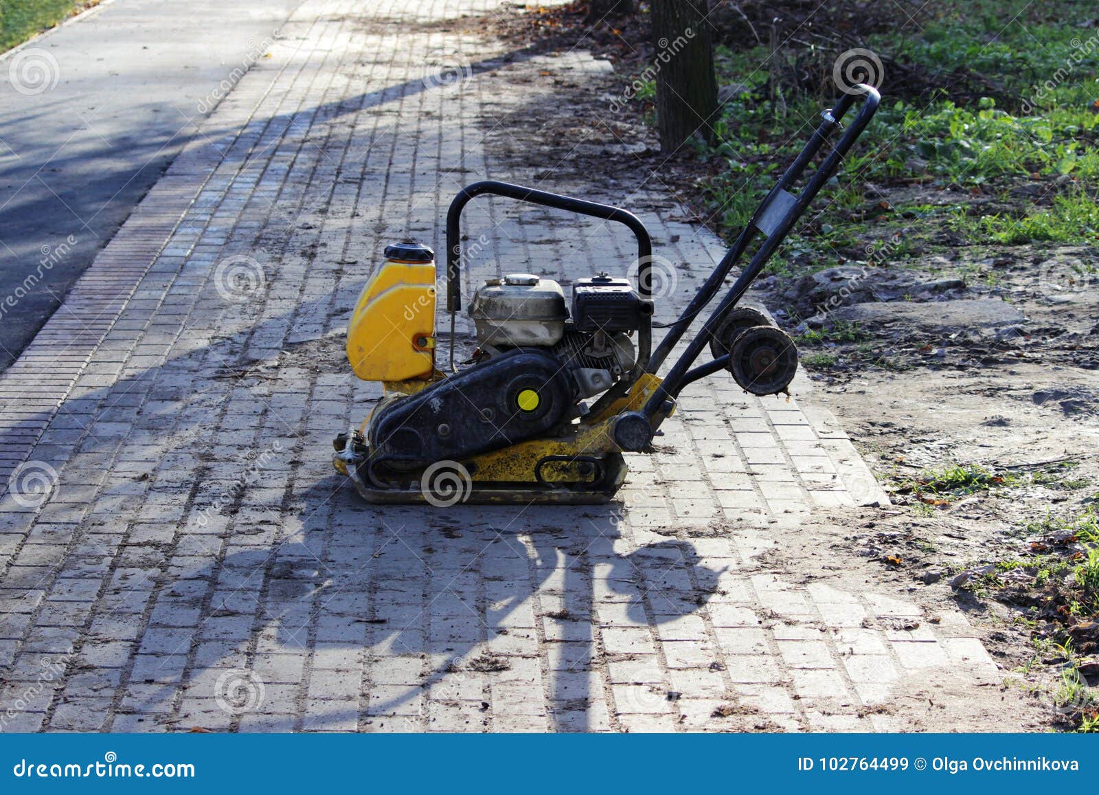 Small Yellow Compactor Standing on New Gray Pavement Stock Image ...
