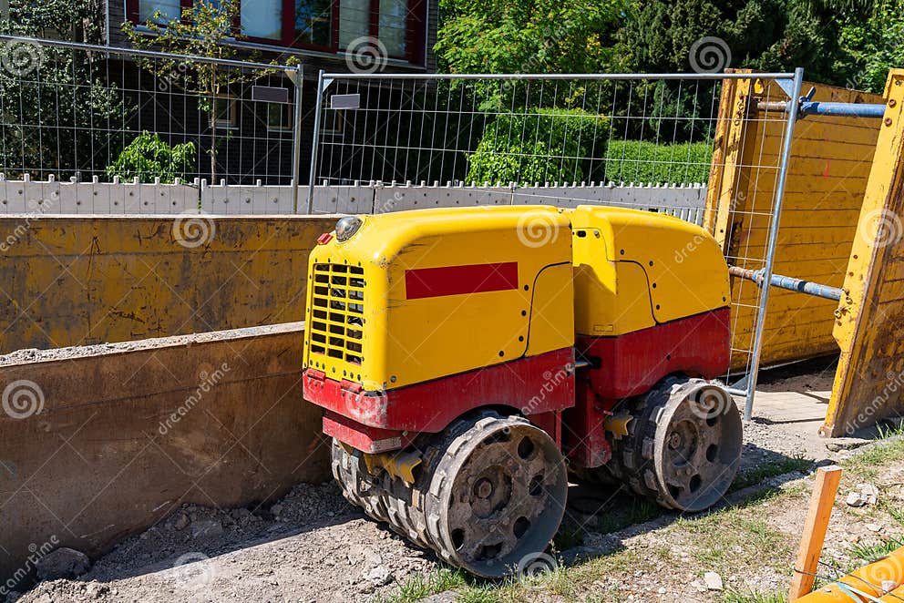 Small Yellow Construction Roller for Compacting Soil at a Construction ...