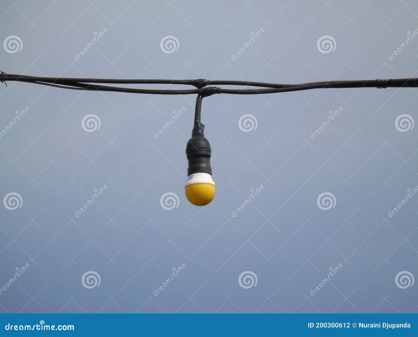 A small, yellow light bulb stock photo. Image of bulb - 200300612