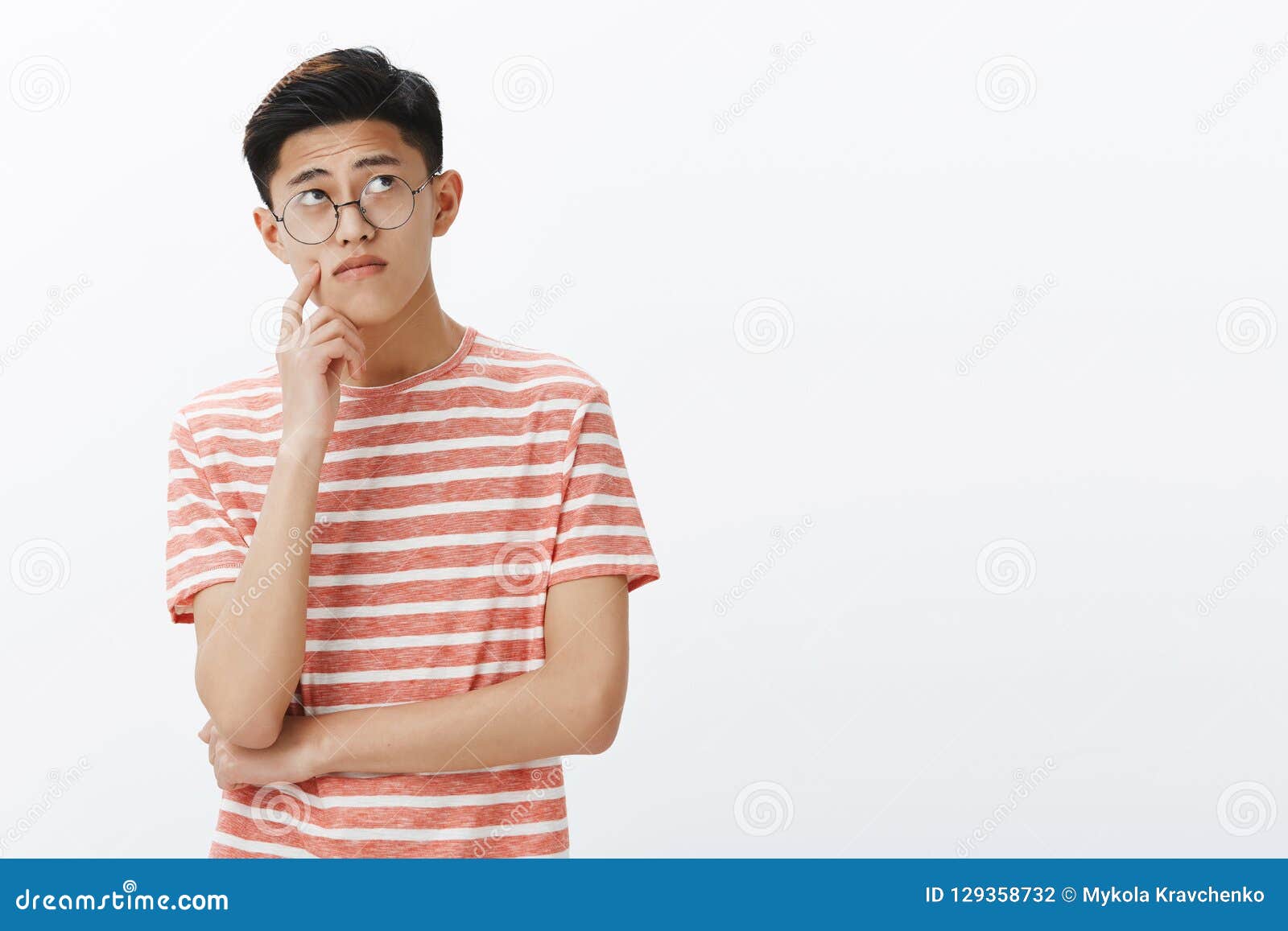 Smart Asian Guy Solving Puzzle in Mind Looking Thoughtful and Relaxed ...