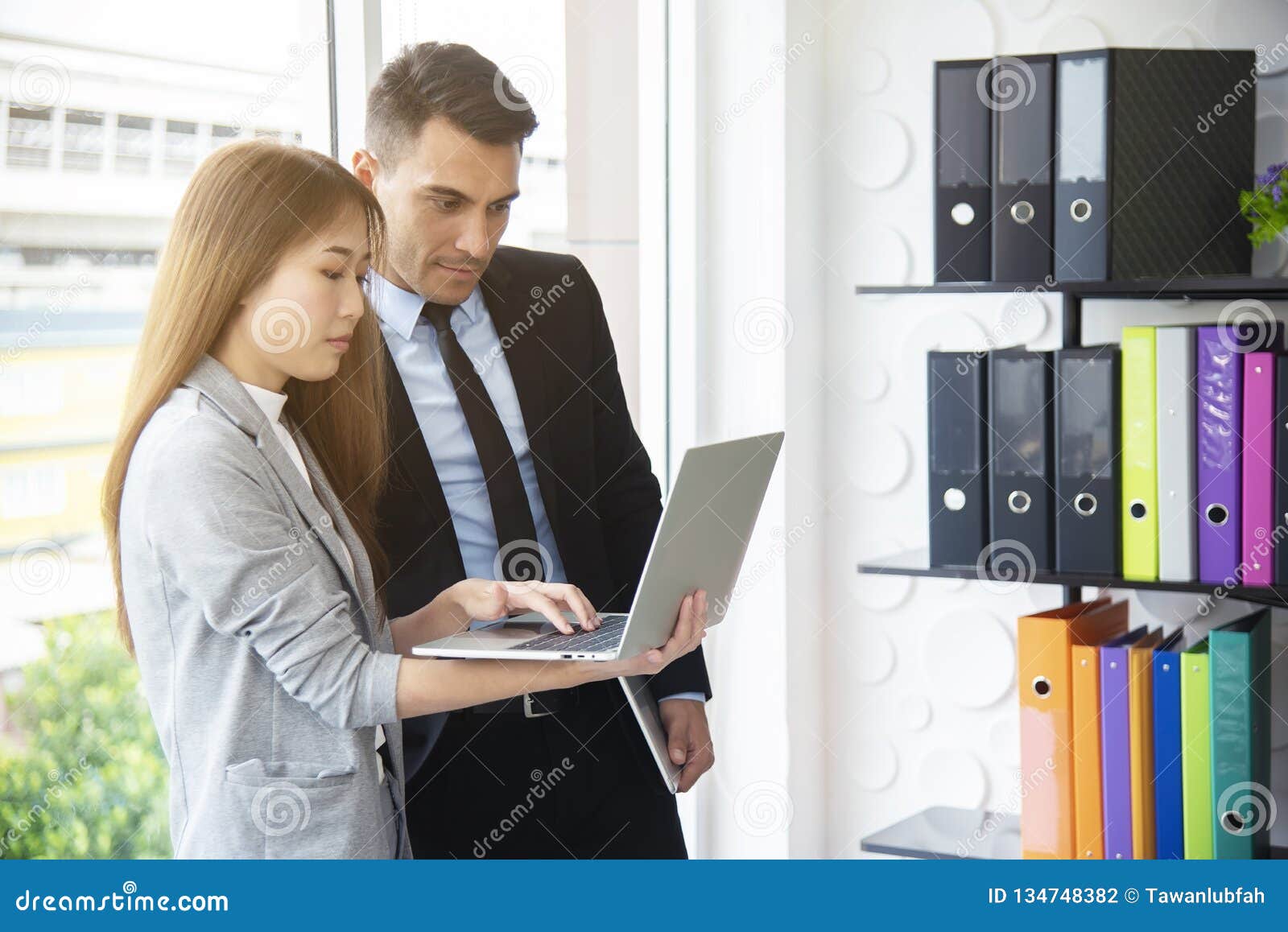 Smart Boss and Secretary Working Together with Laptop in Office Stock ...